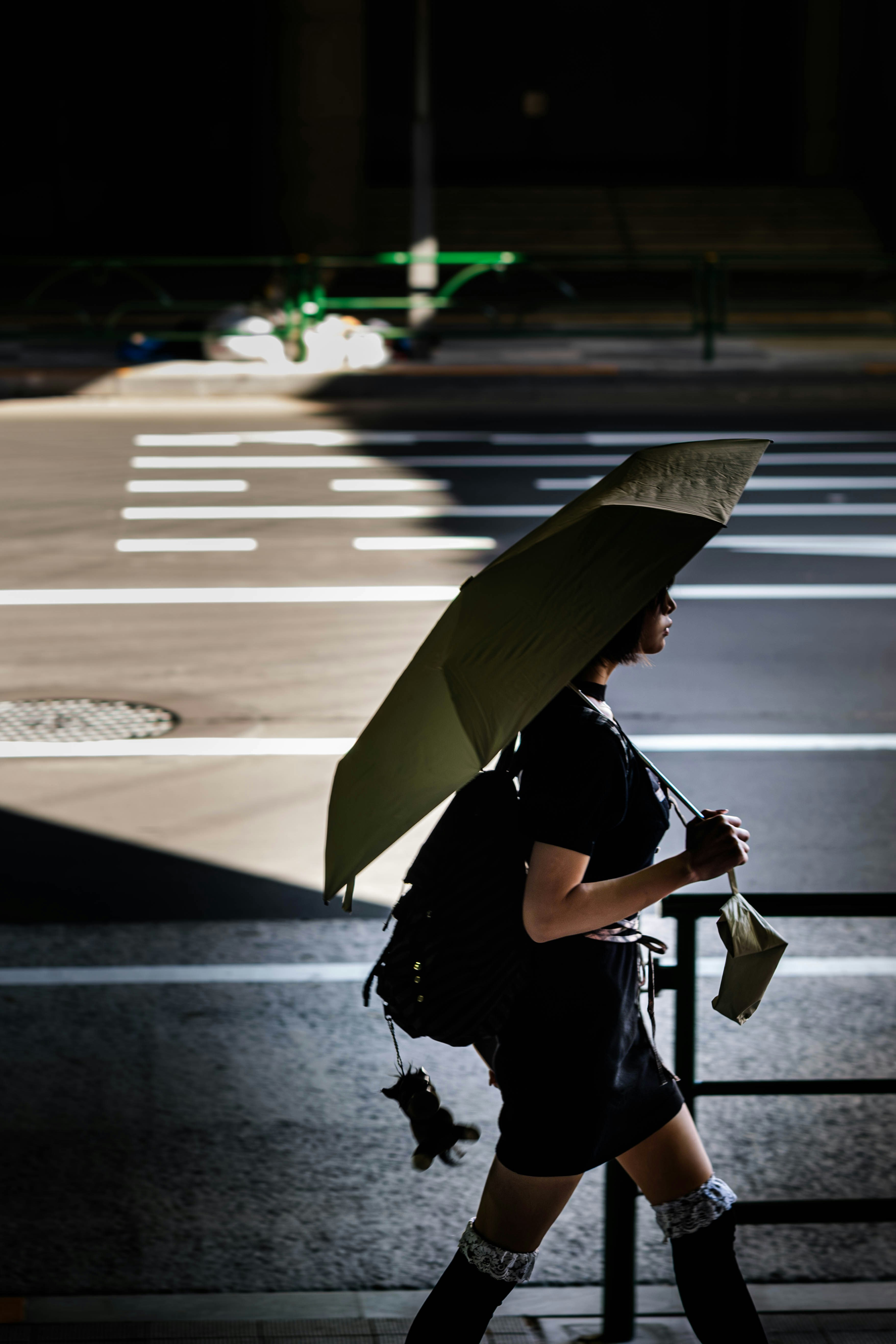 Umbrella in the Streetlight: A Quiet Street Moment with a Walking Figure