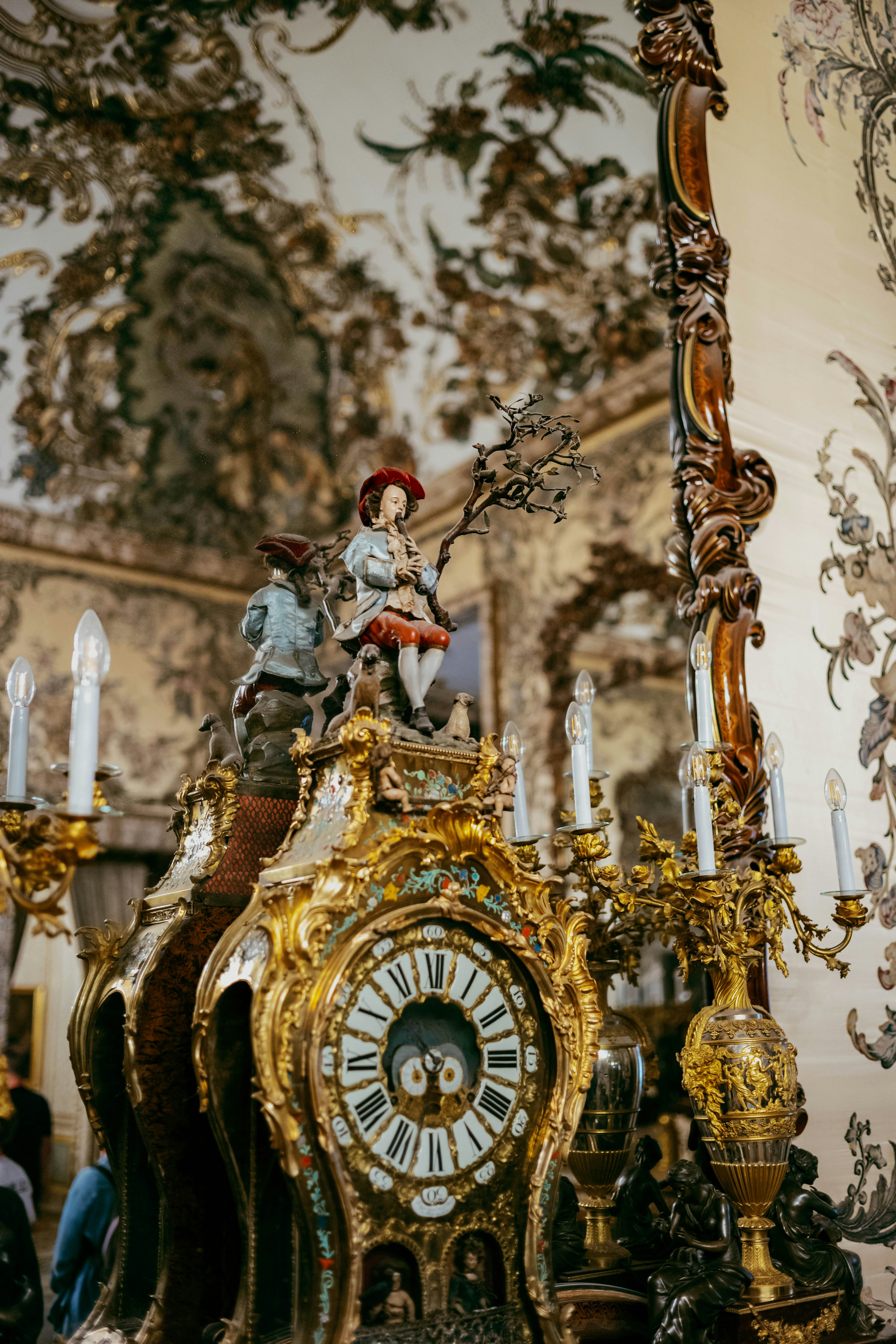 Ornate Clockwork Crown: Baroque Sculptures Surrounded by Candlelit Splendor
