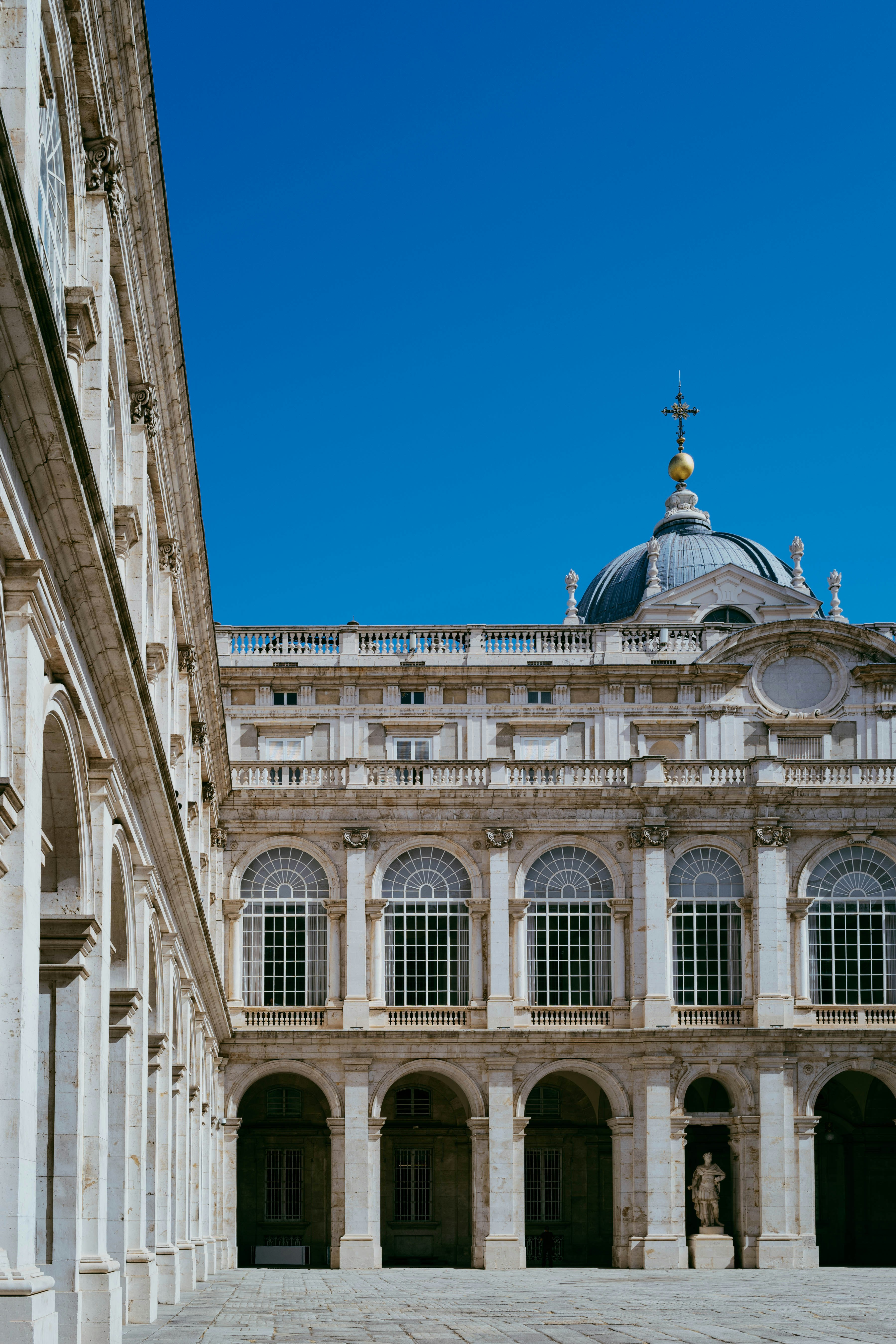 Grand classical palace architecture under a clear blue sky.