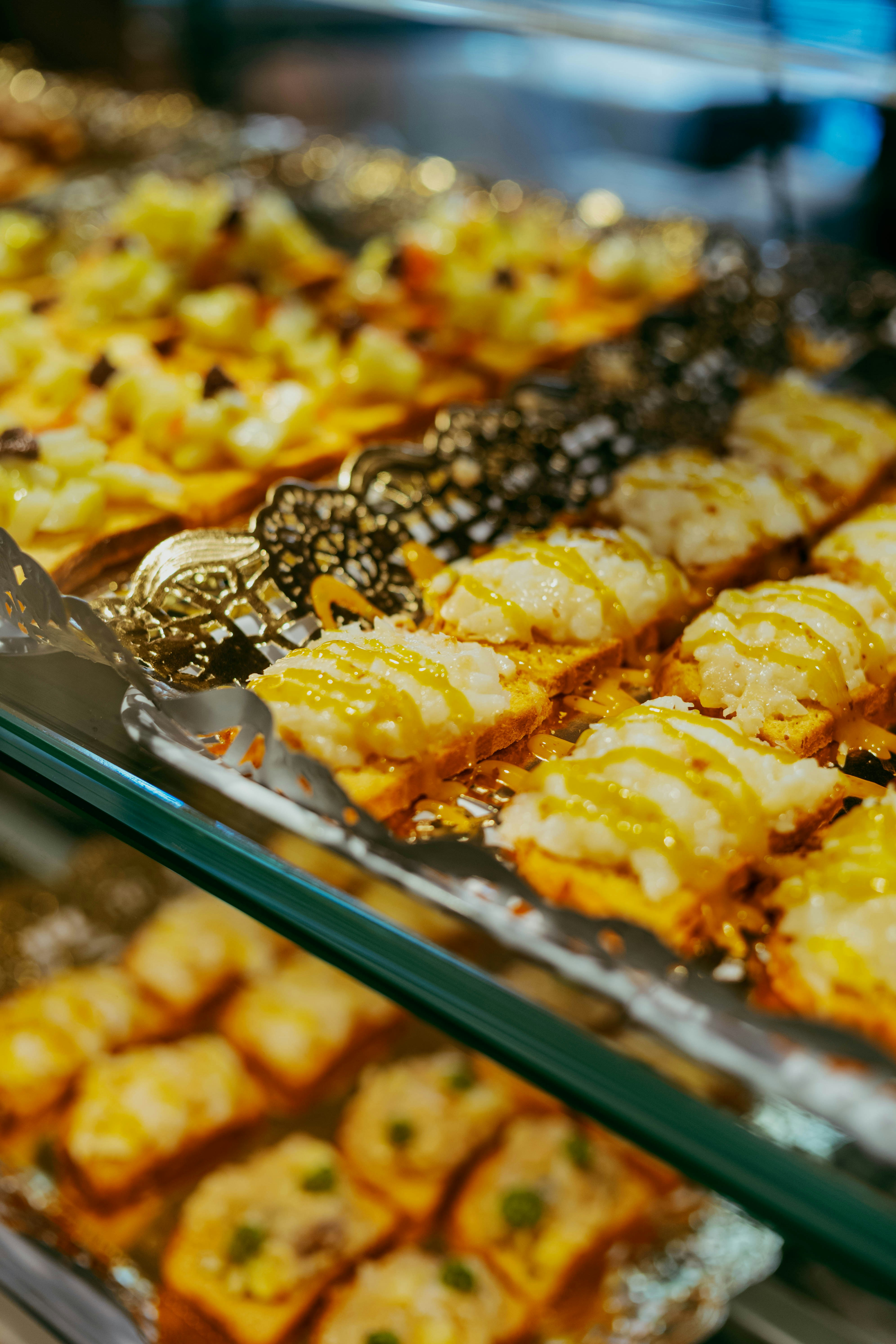 Glazed Sushi Rows: Golden Bites Behind a Glass Showcase