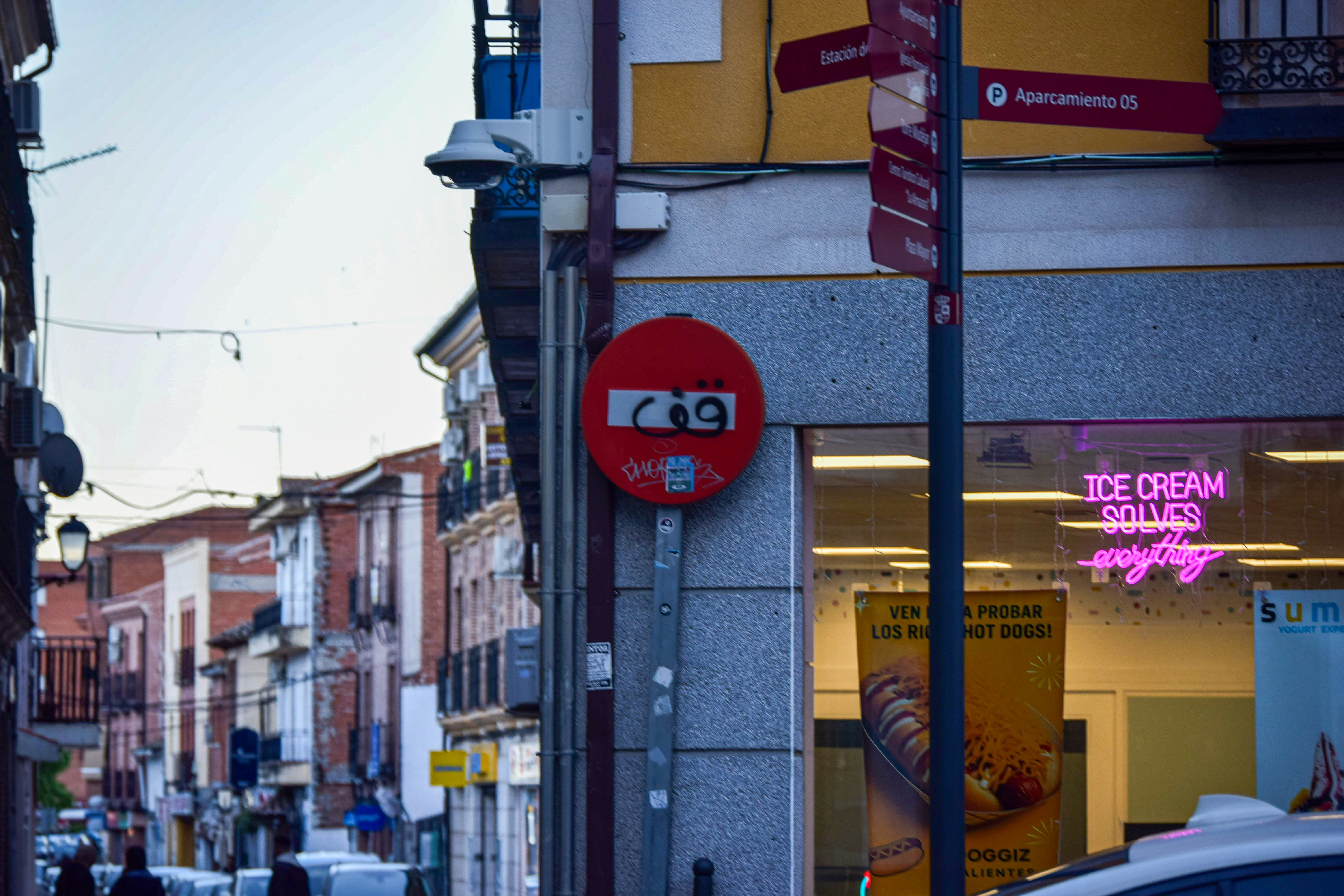 Neon glow and corner café on a sunlit urban street