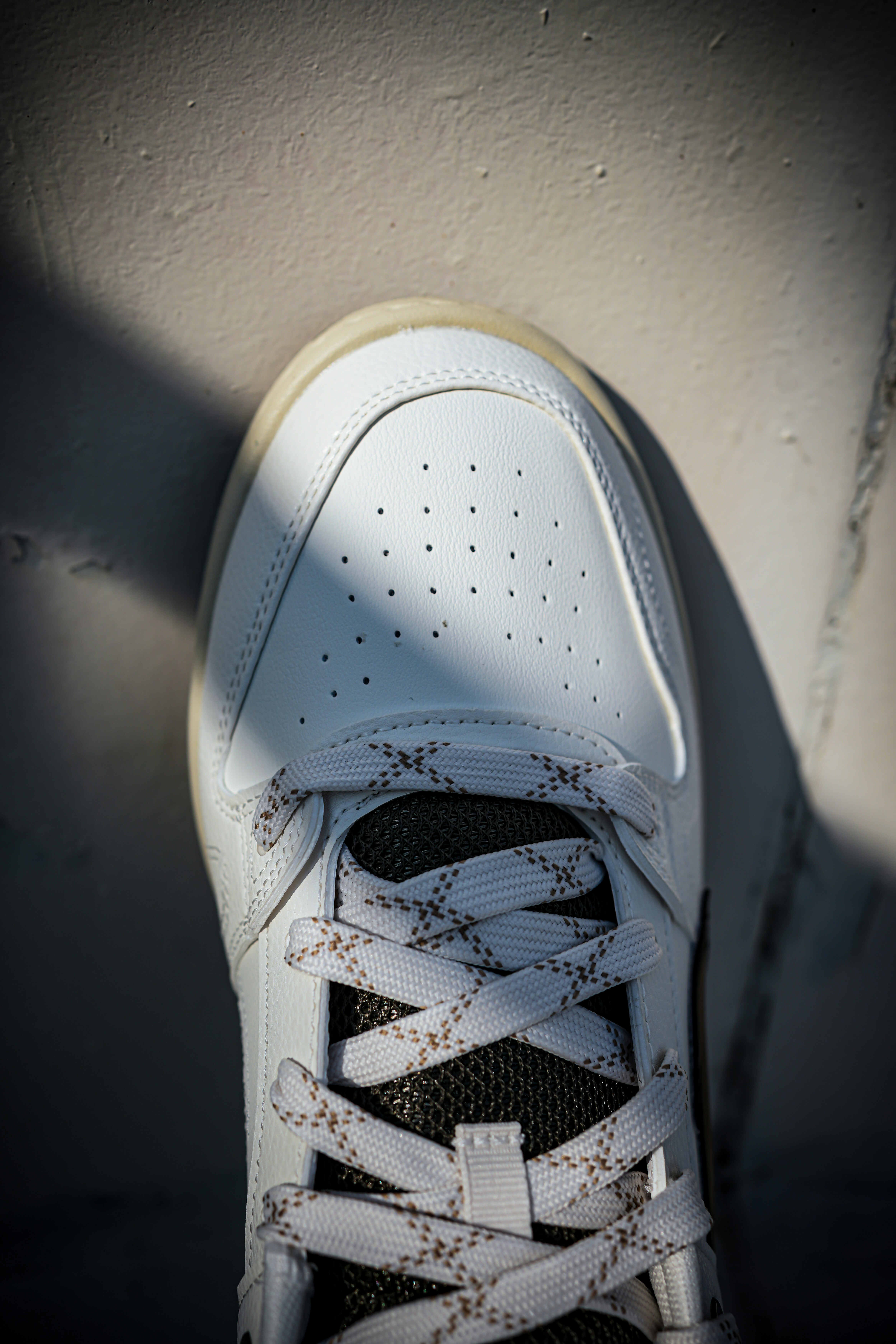 Step into the Shot: The White Sneaker Crowned by Shadow
