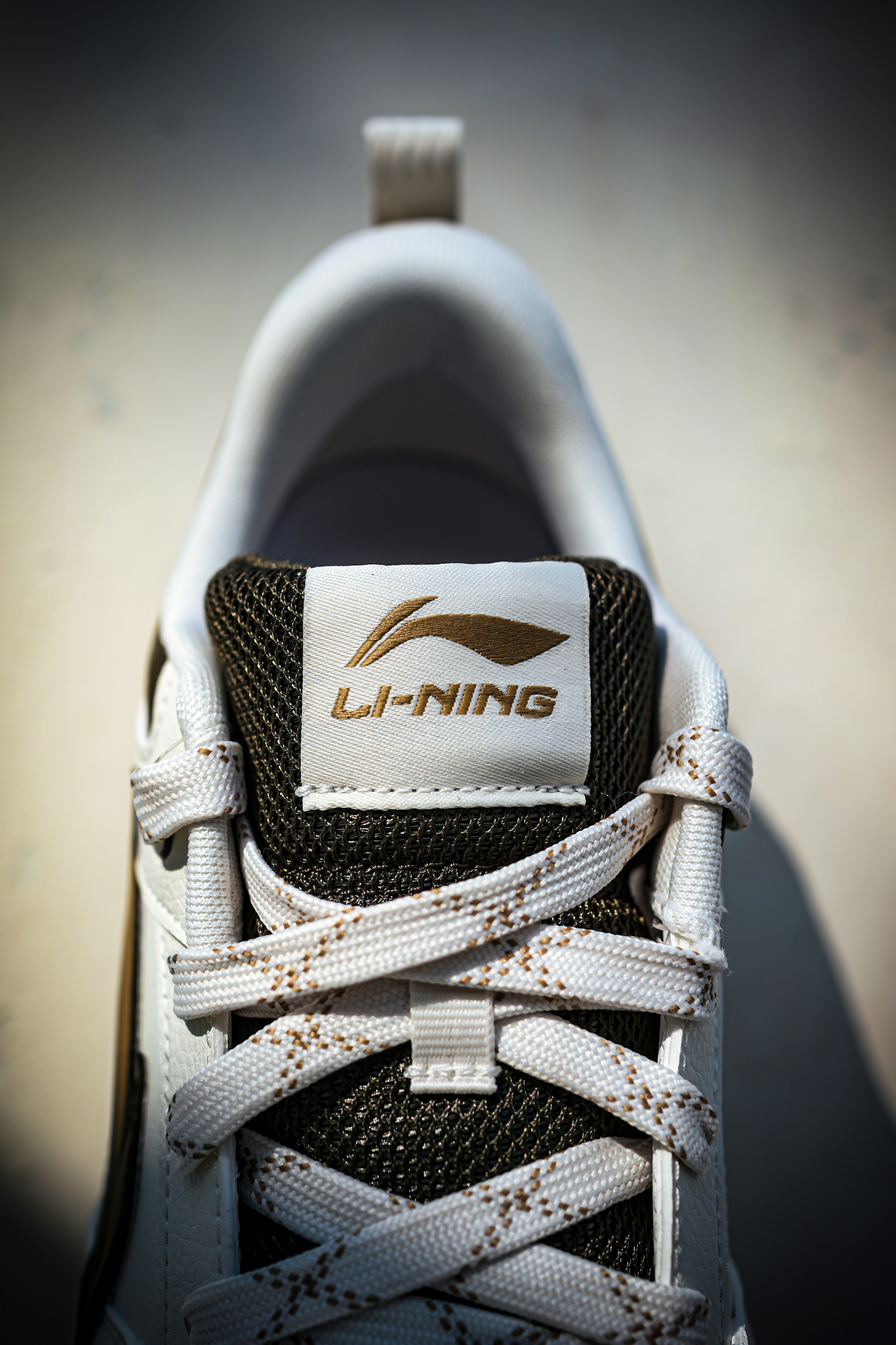 Close-Up of a Li-Ning Sneaker Tongue: Brand Craft on White Mesh