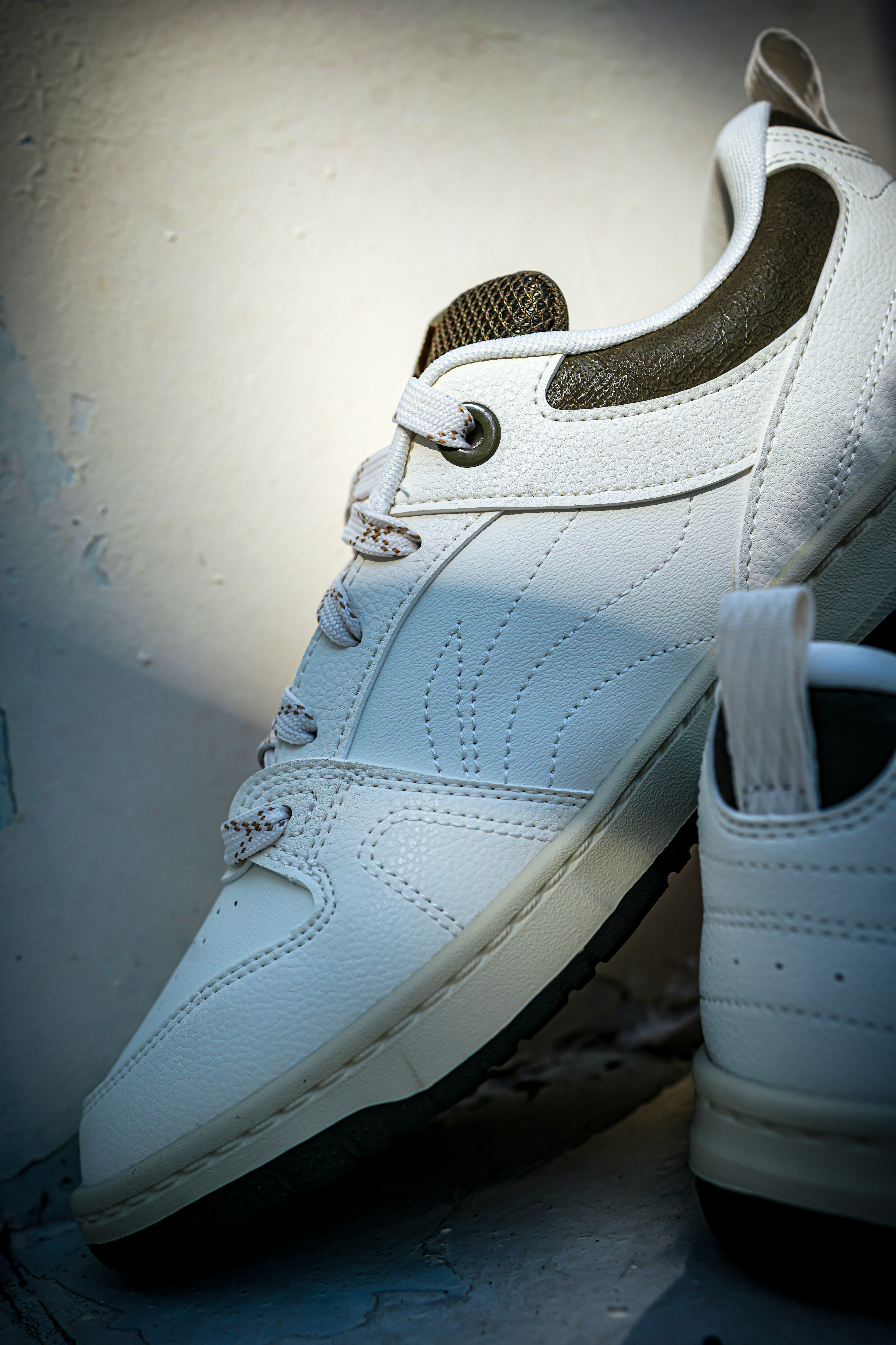 Close-Up of White Sneaker Details: stitched leather, laces and Heel Tab
