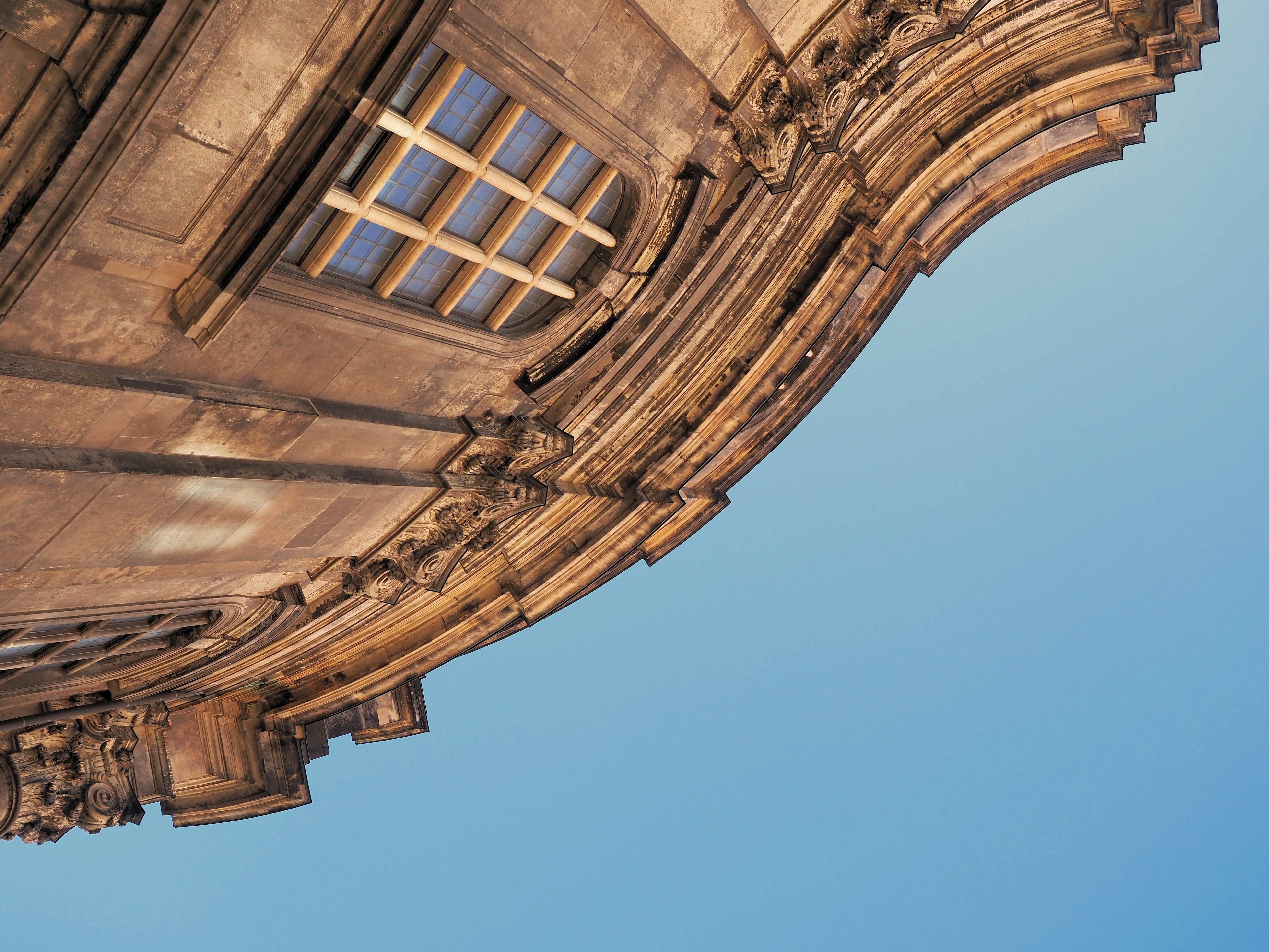 Curved Facade of Historic Stone Architecture Under Clear Sky
