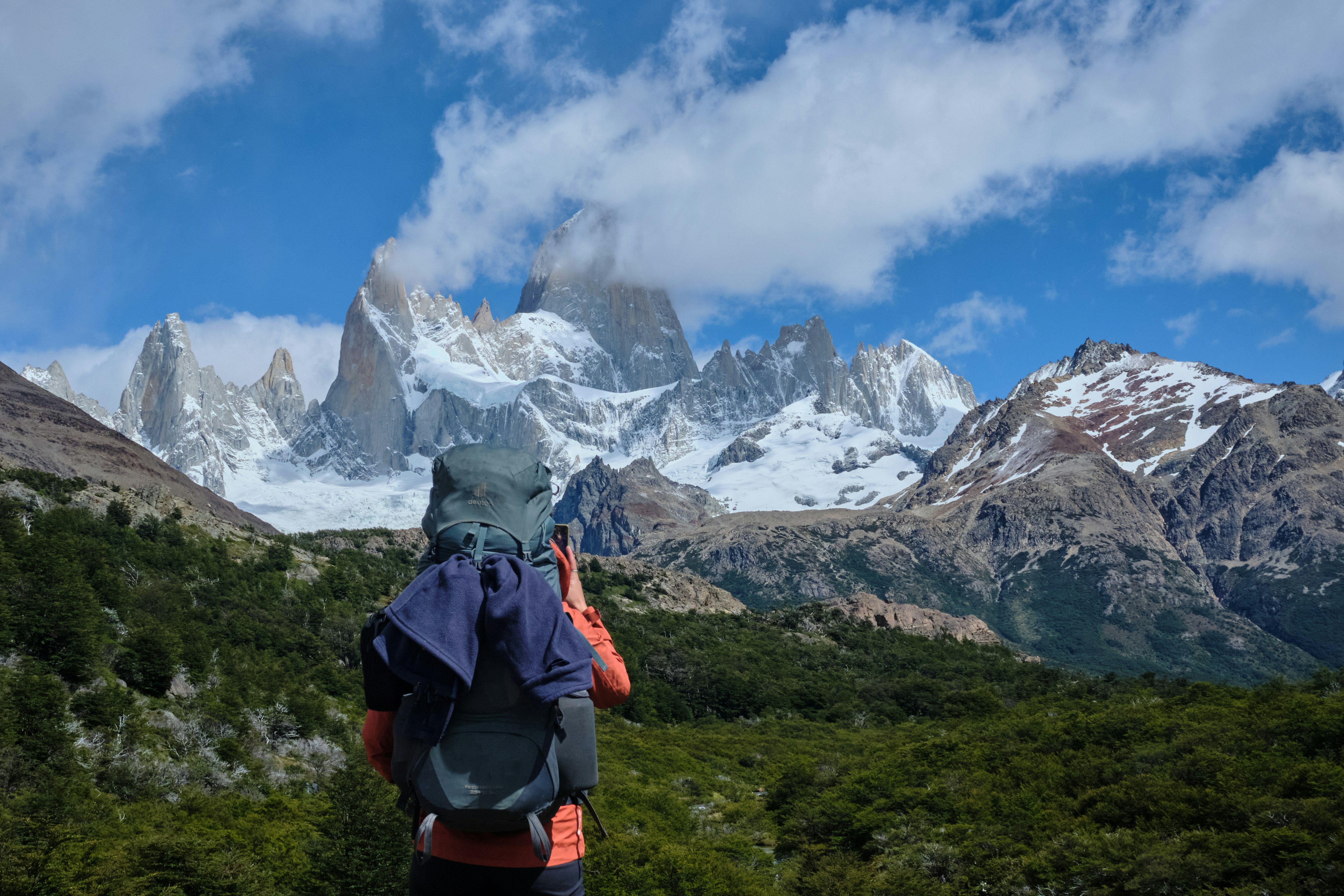 Backpacker's Ascent: Faces Mountains in the Mist