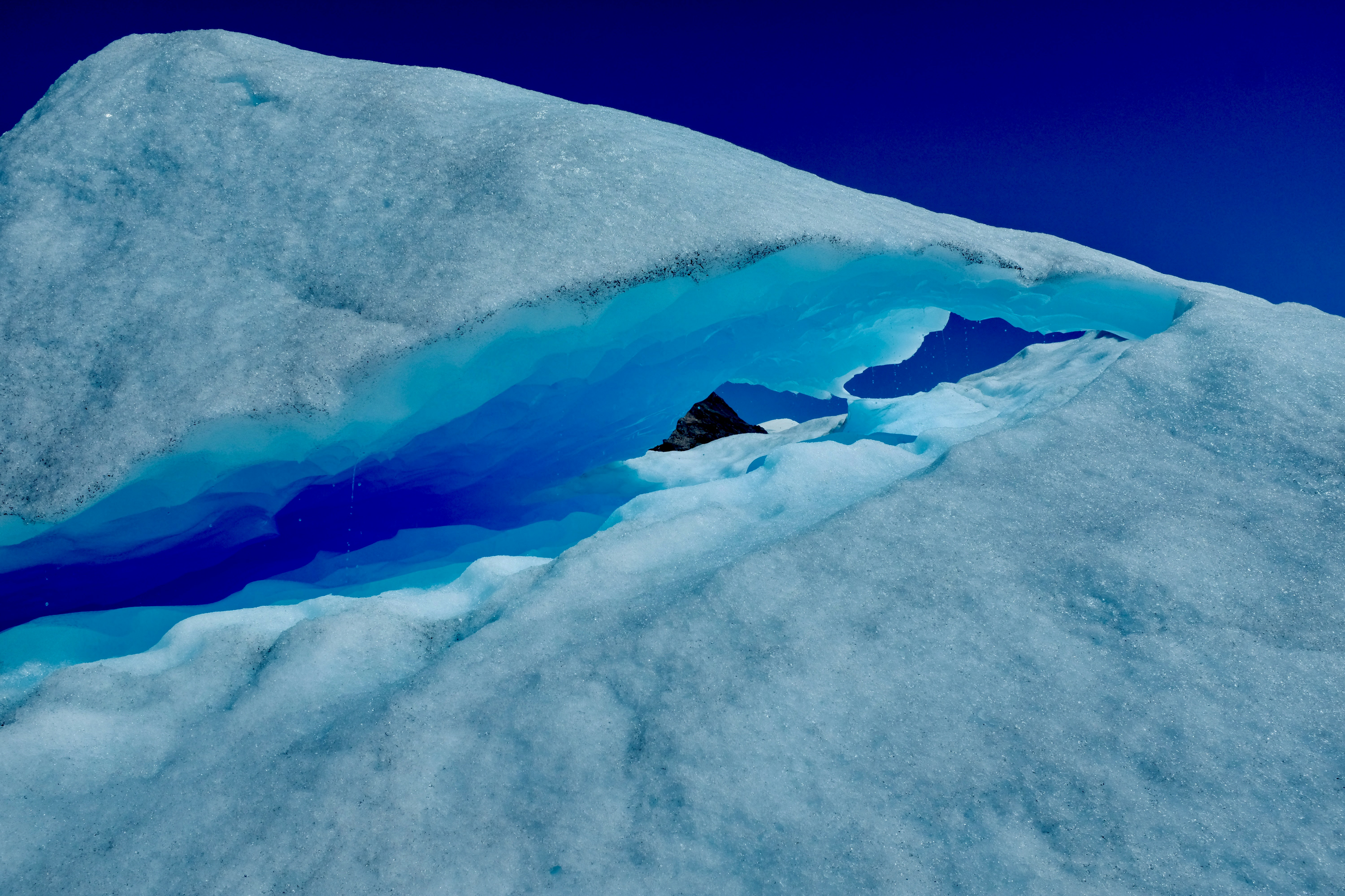 Glacial Crevice Under a Velvet Blue Sky