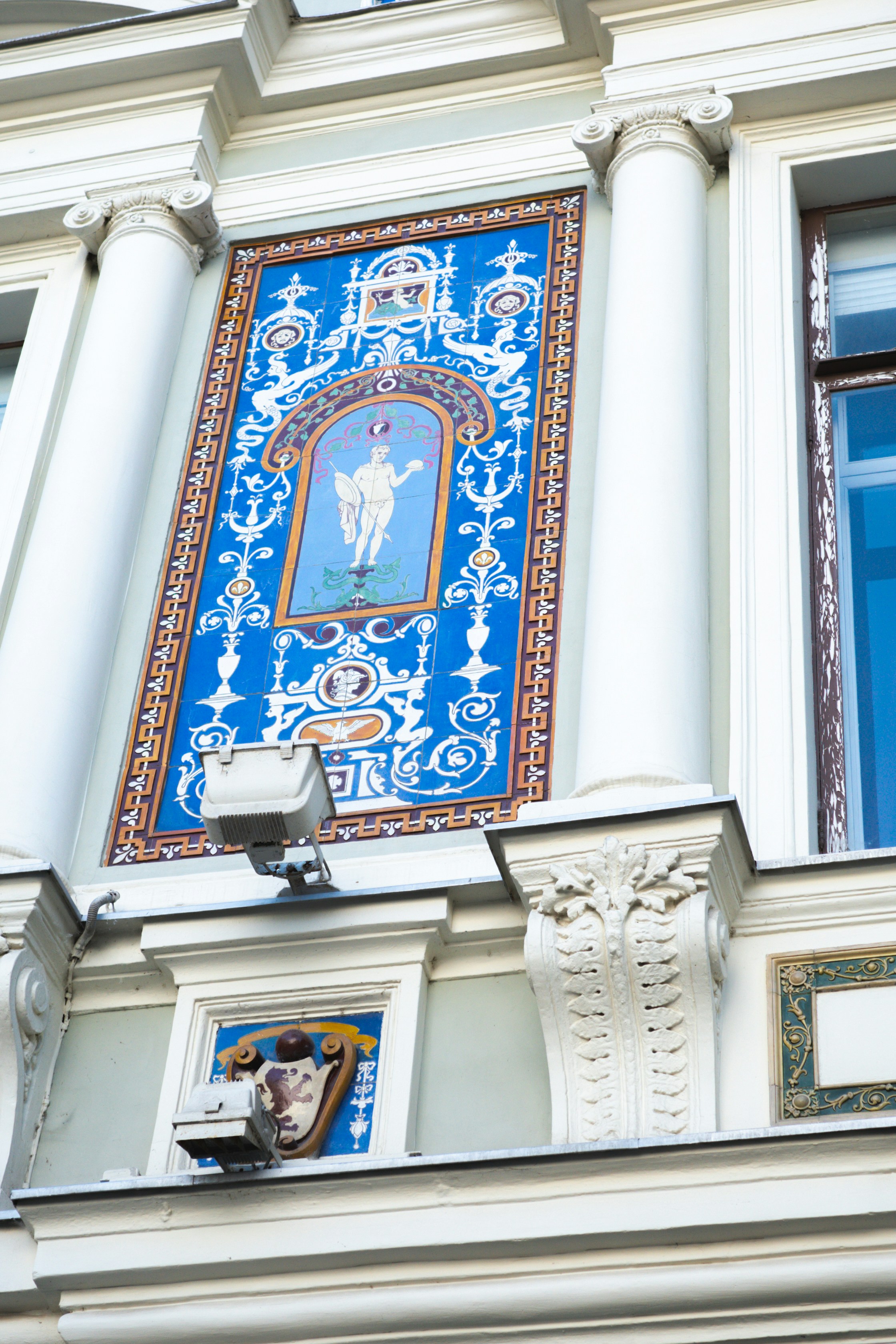 Blue Tile Panel Framed by Classical Columns on a Historic Facade