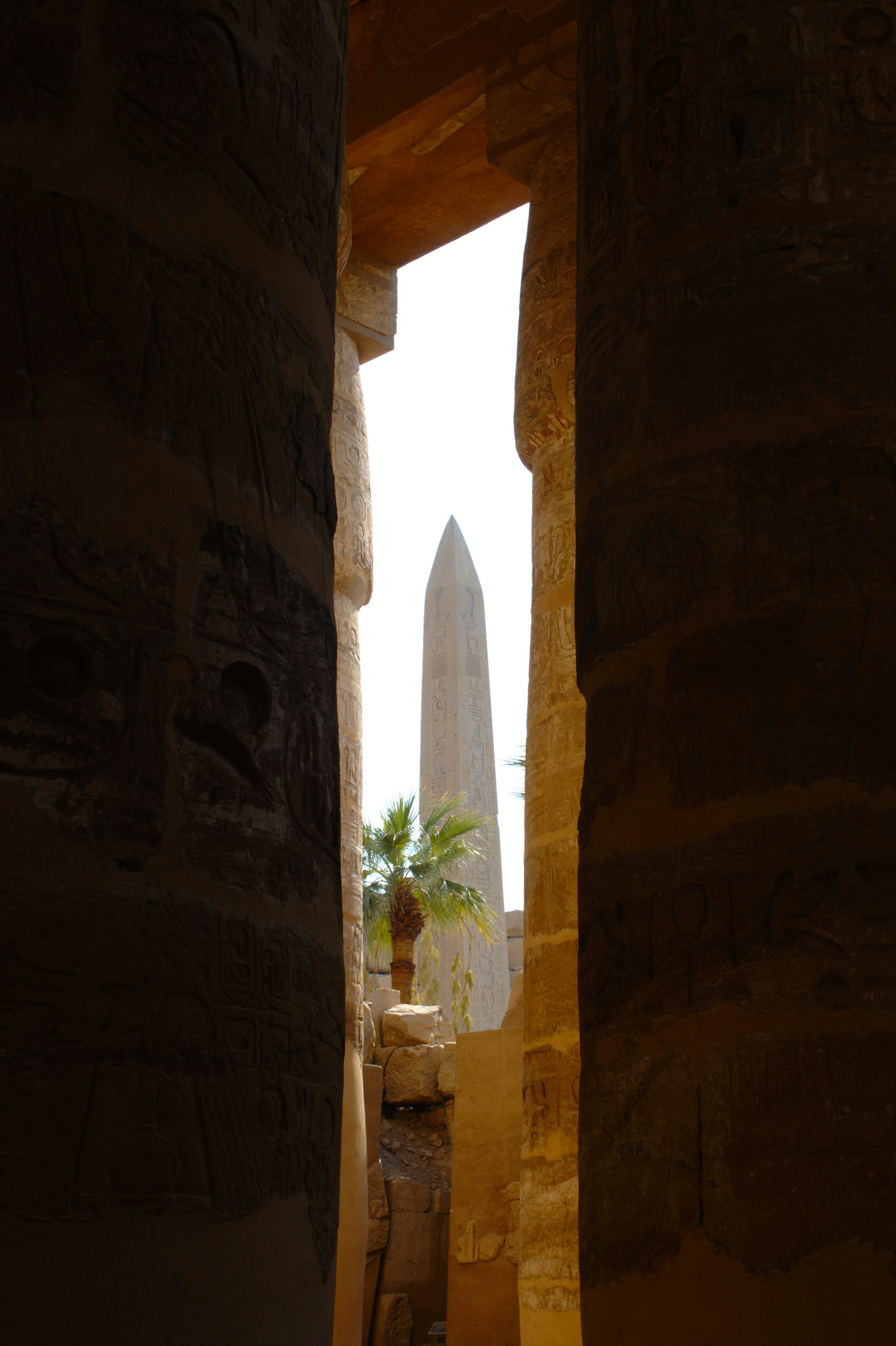 Margins of Light: An Obelisk Framed by Ancient Pillars