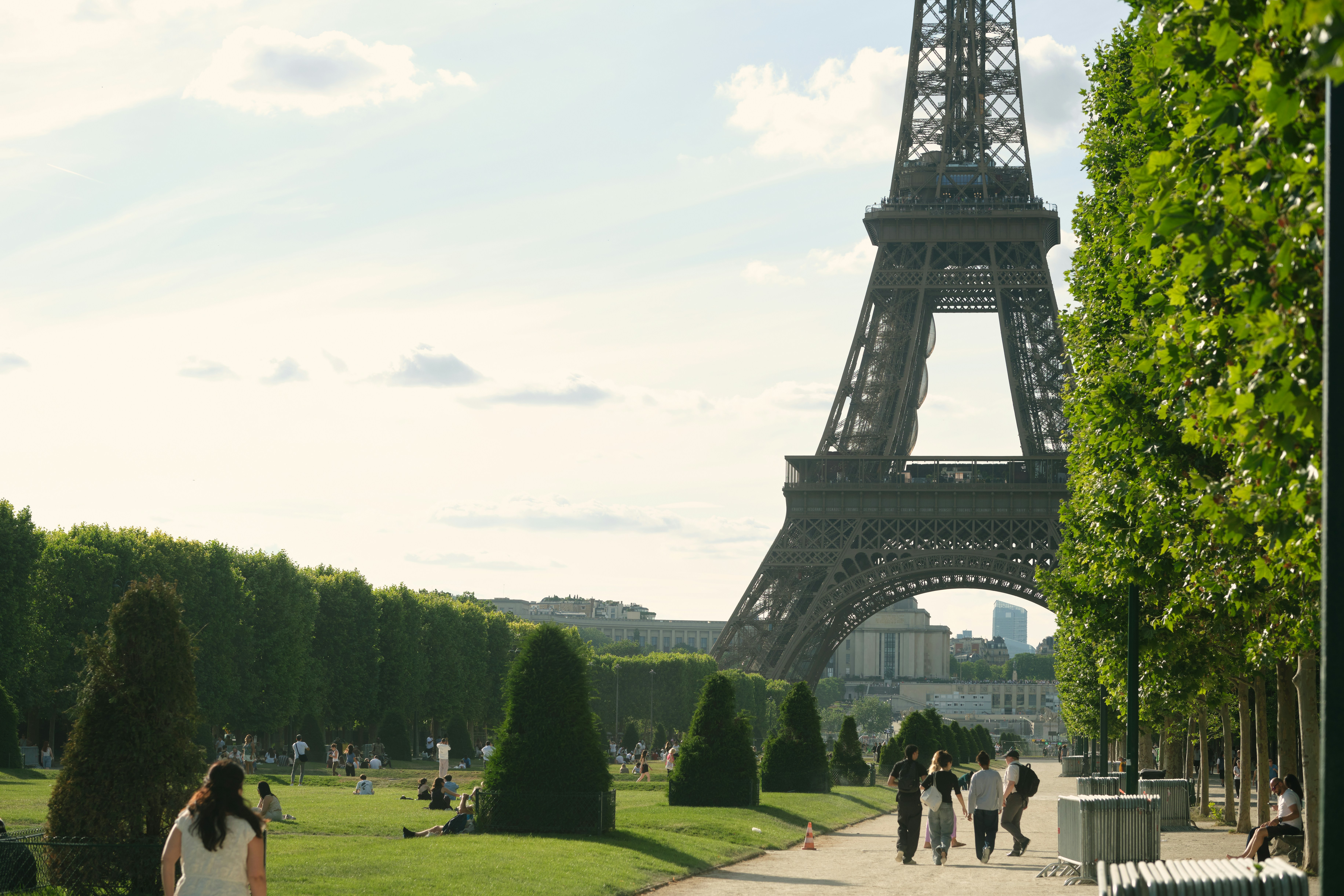 Parisian Promenade: The Eiffel Tower Framed by a Lively Riverside Walk