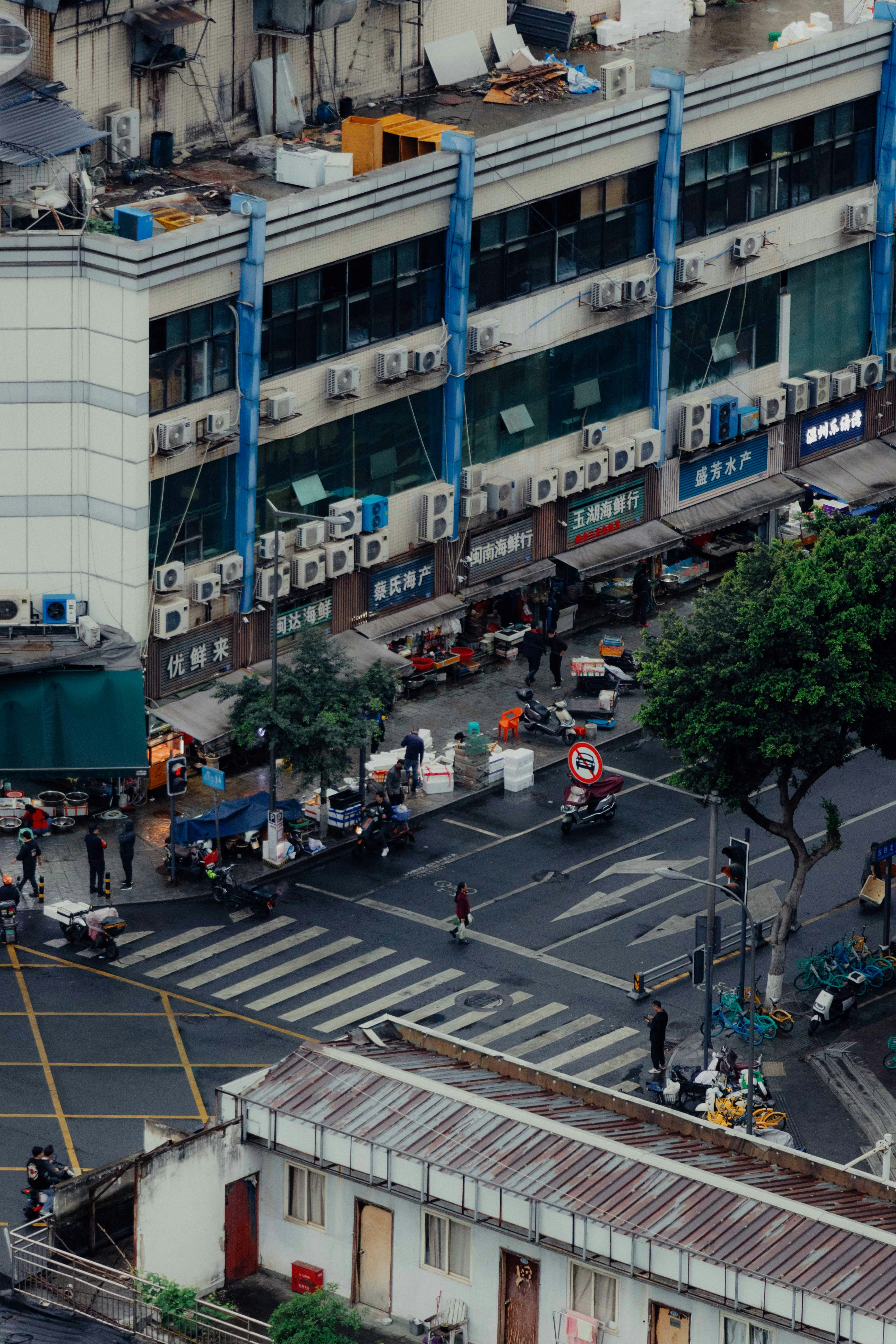 Aerial Street Scene: Busy Pedestrian Crossing Beneath a Commercial Facade