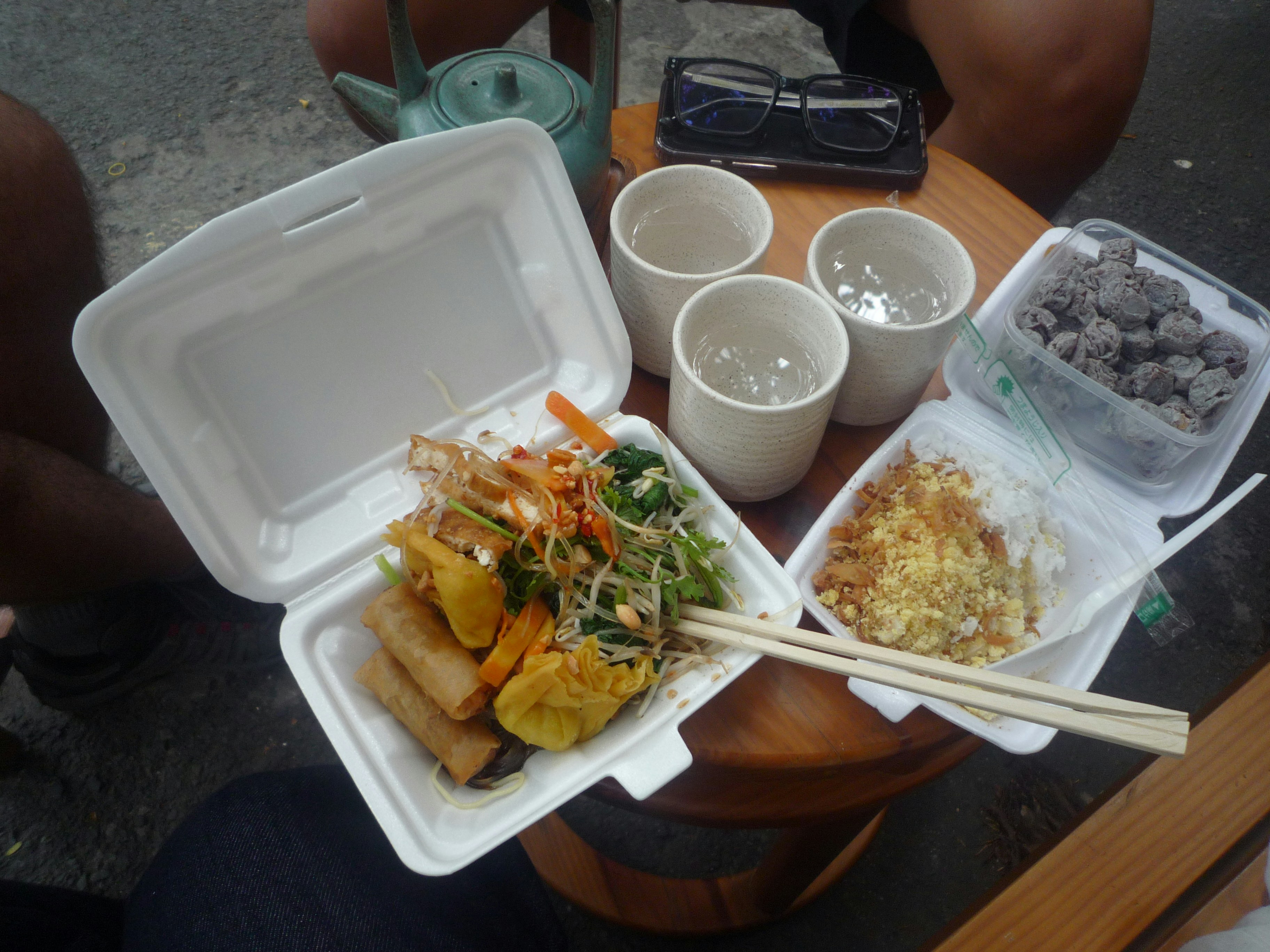 Street Feast in a Foam Box: Chopsticks and Sauce on a Round Table