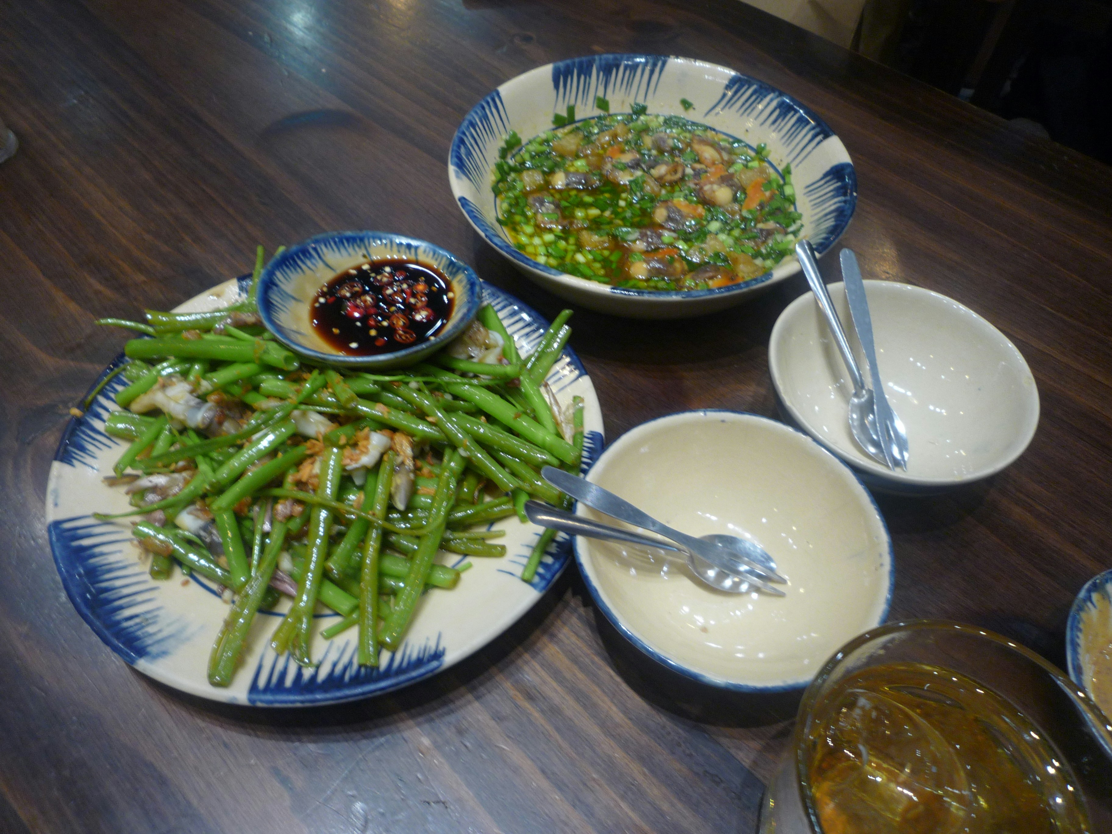 Delicious asian meal with green beans, sauce, and soup.
