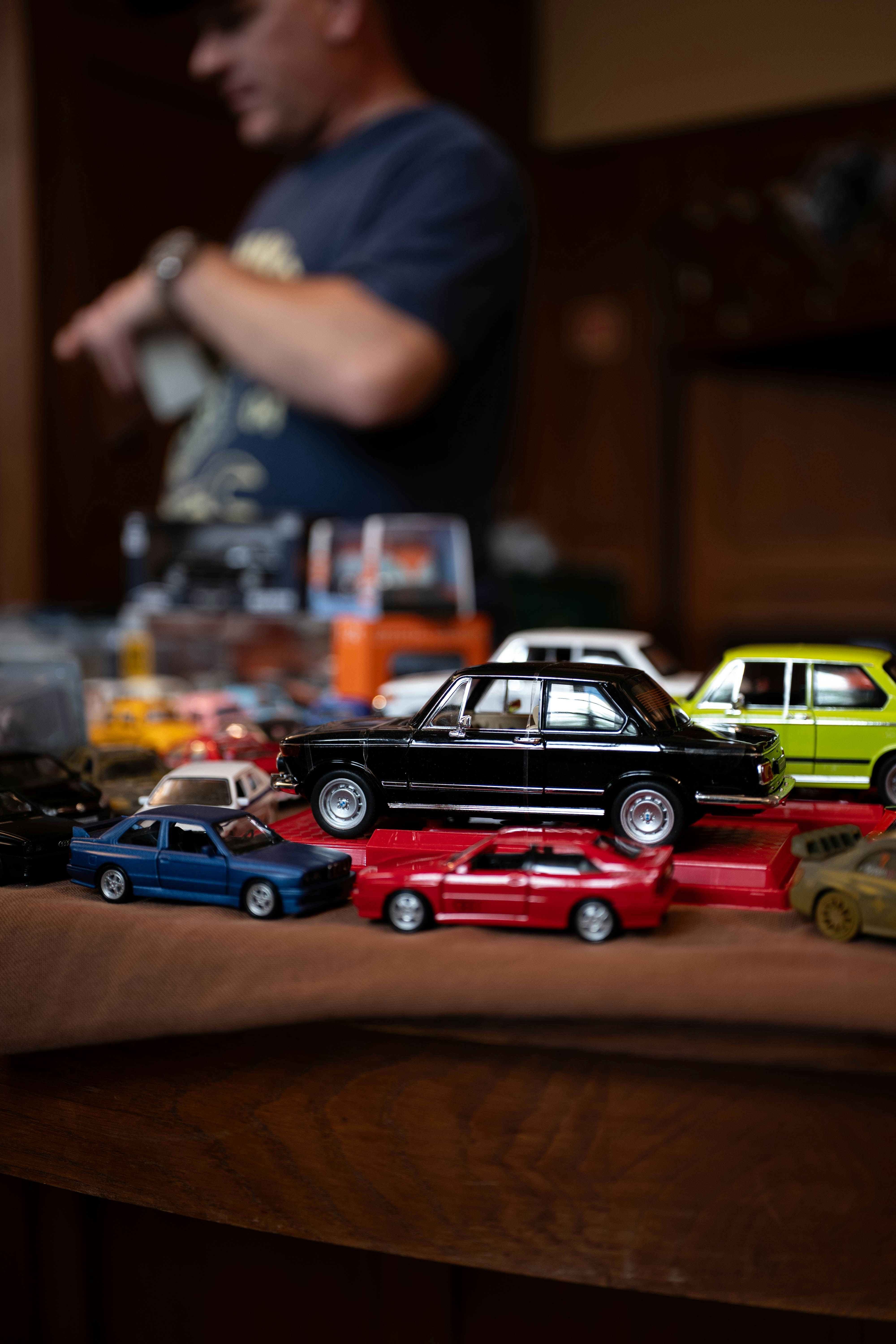 Miniature Car Parade on a Wooden Stage