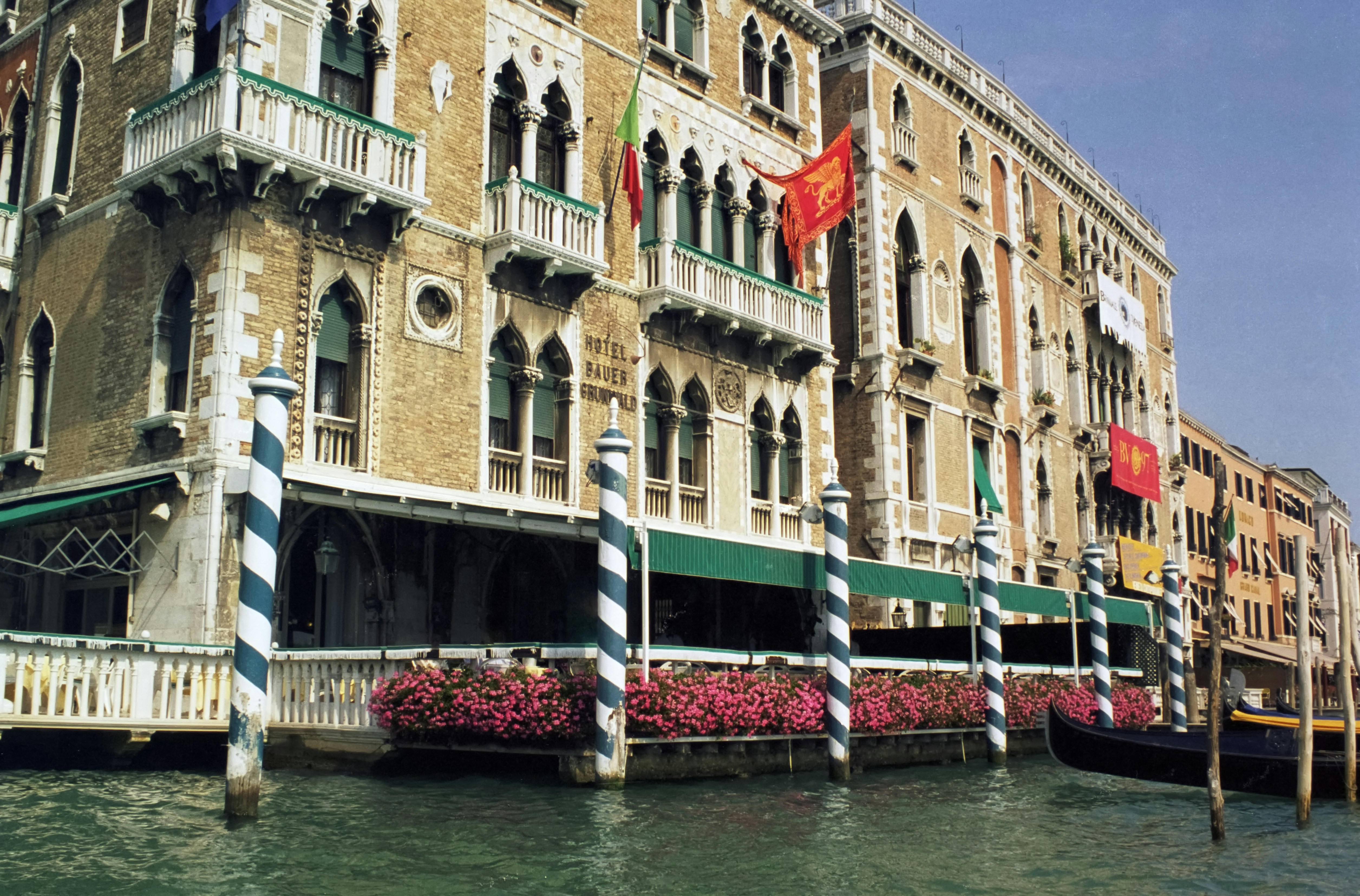 Cerulean Canalfront: Venetian-Style Buildings Rise Over Blooming Pontoons