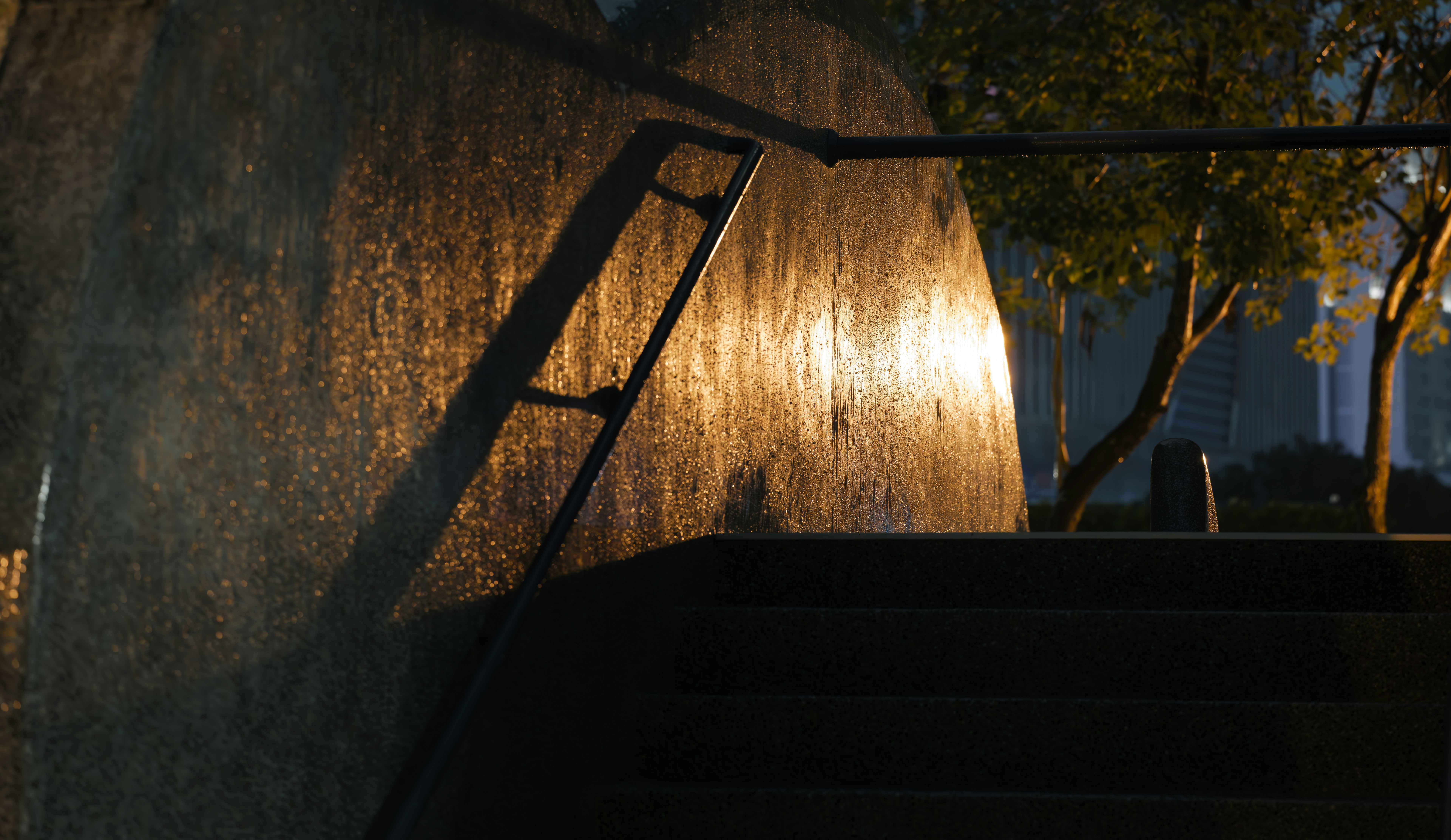 Echoing Waterwall at Dusk: Concrete Steps and Light Spray