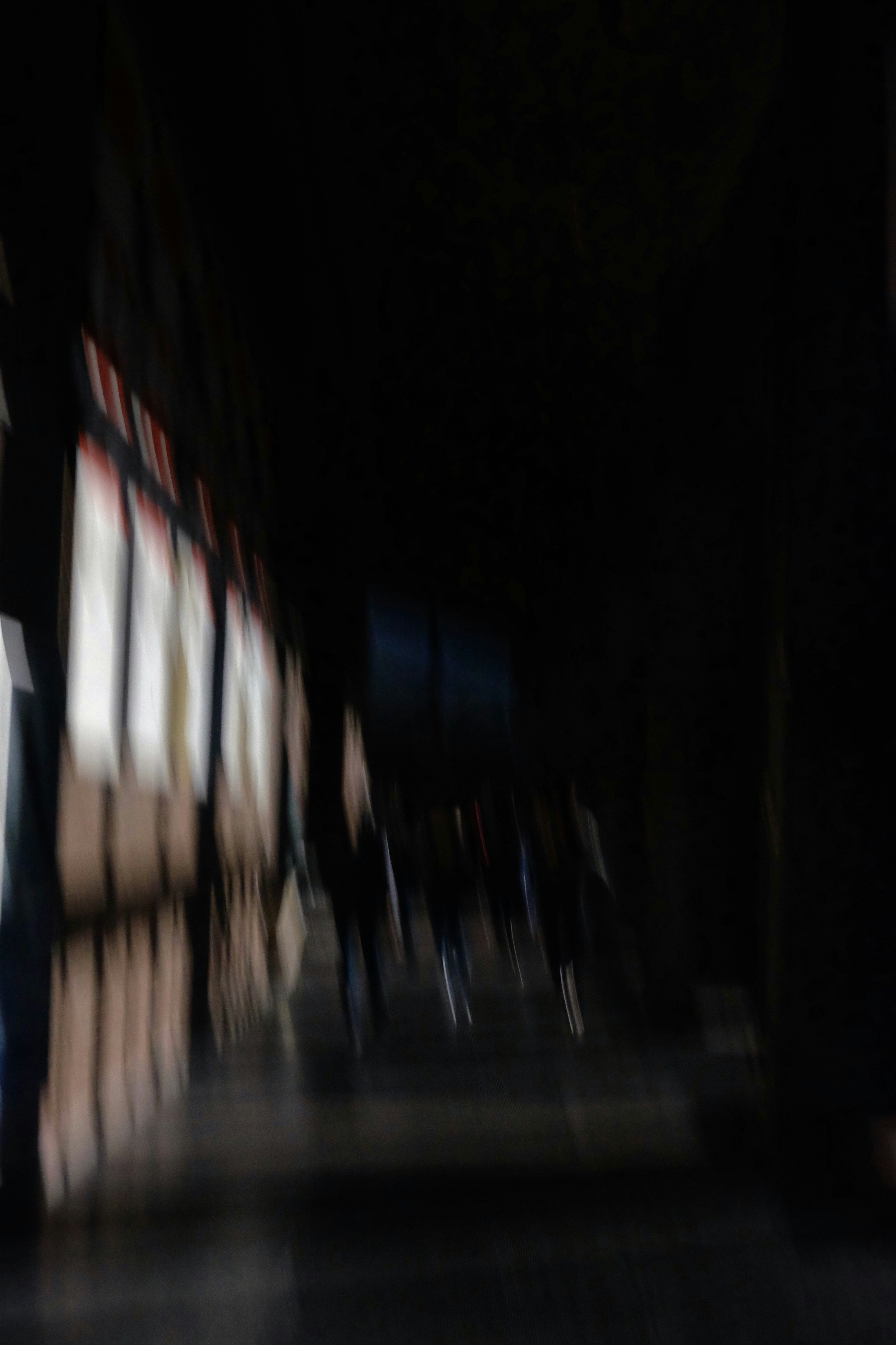 Shadowed Corridor: A Blurry Stage of People and Paraphernalia