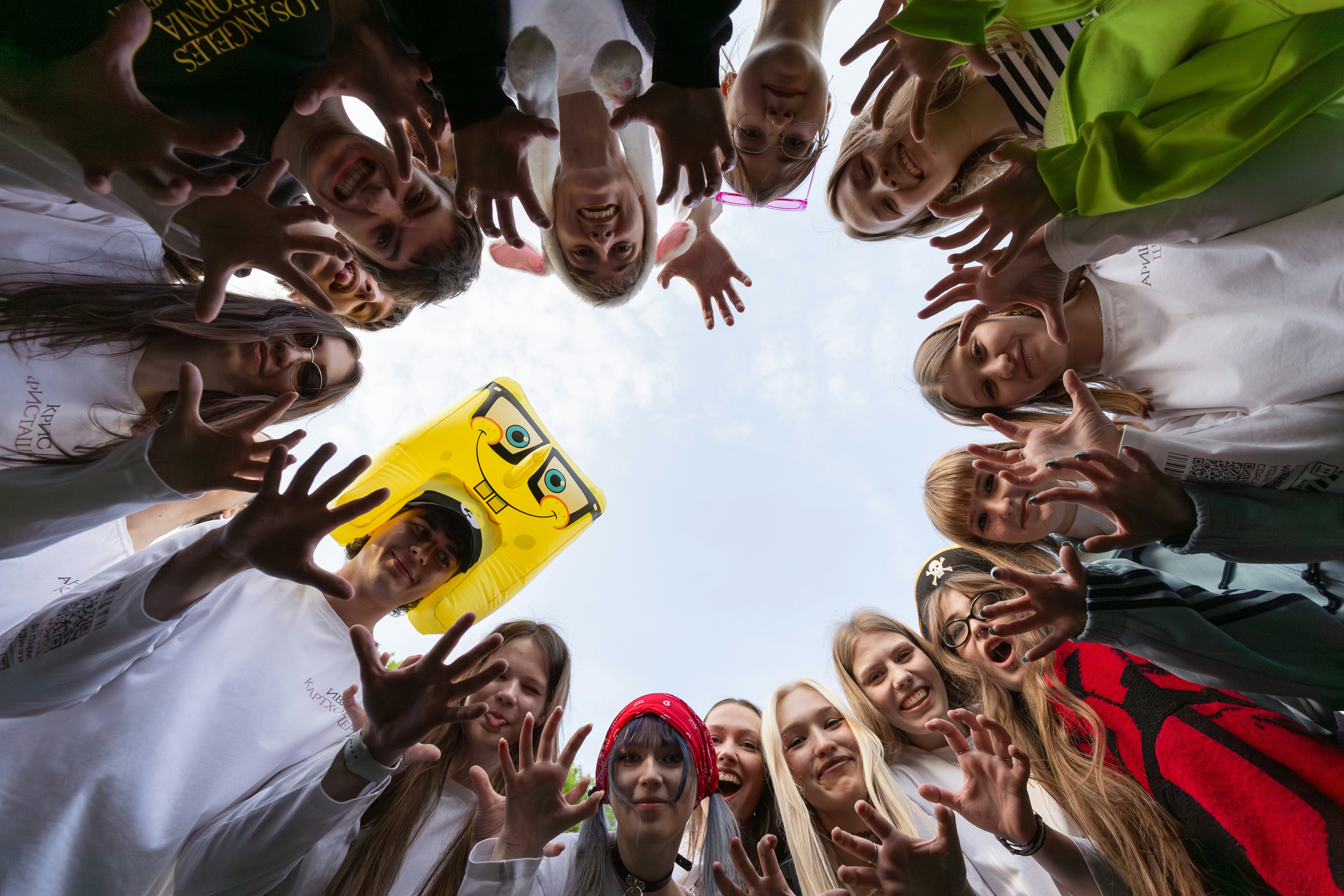 Circle of Cheer: A Ground-Up Group Portrait Under a Bright Sky