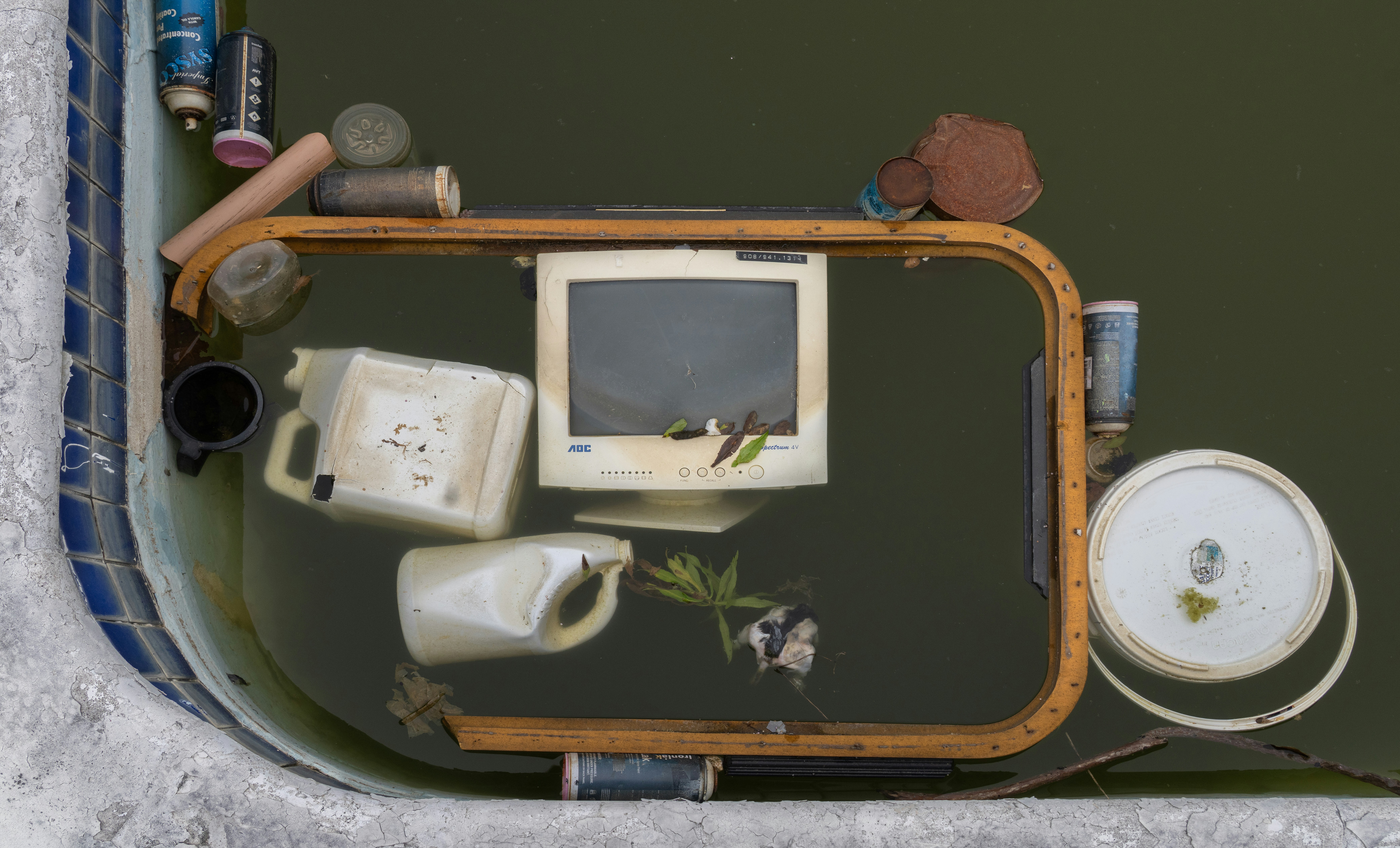 Deserted drown: a discarded monitor amid harbor debris