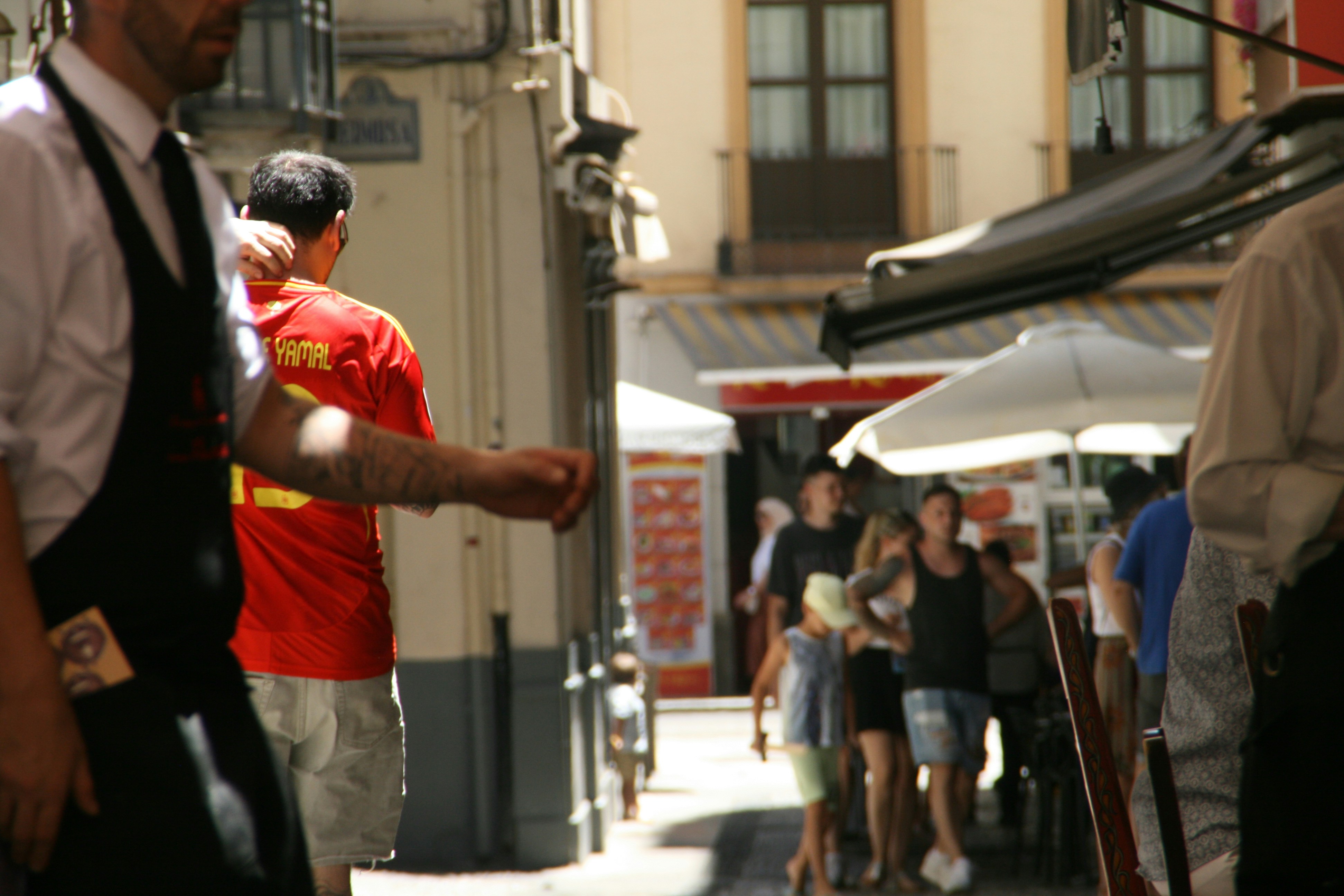 Red-Tee Parade: A Sunlit Alley of Urban Life