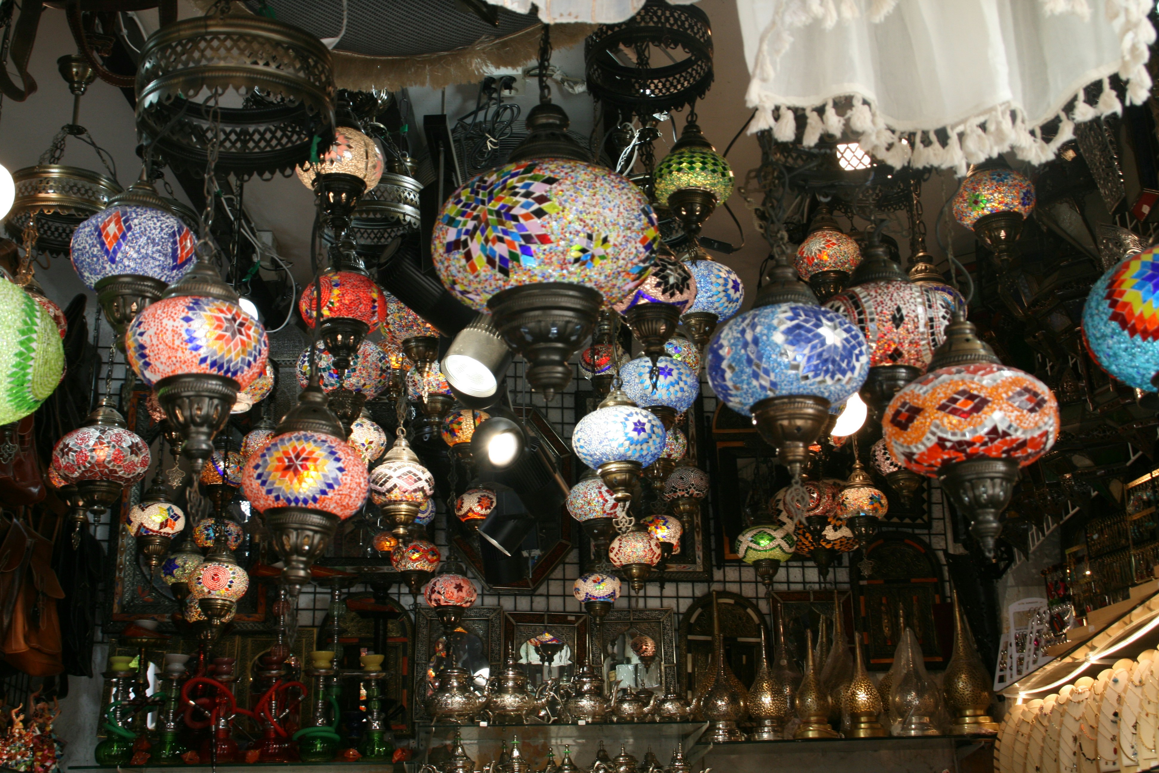 Lanterns in the Bazaar: Mosaic Glass Above a Tangle of Colorful Lamps