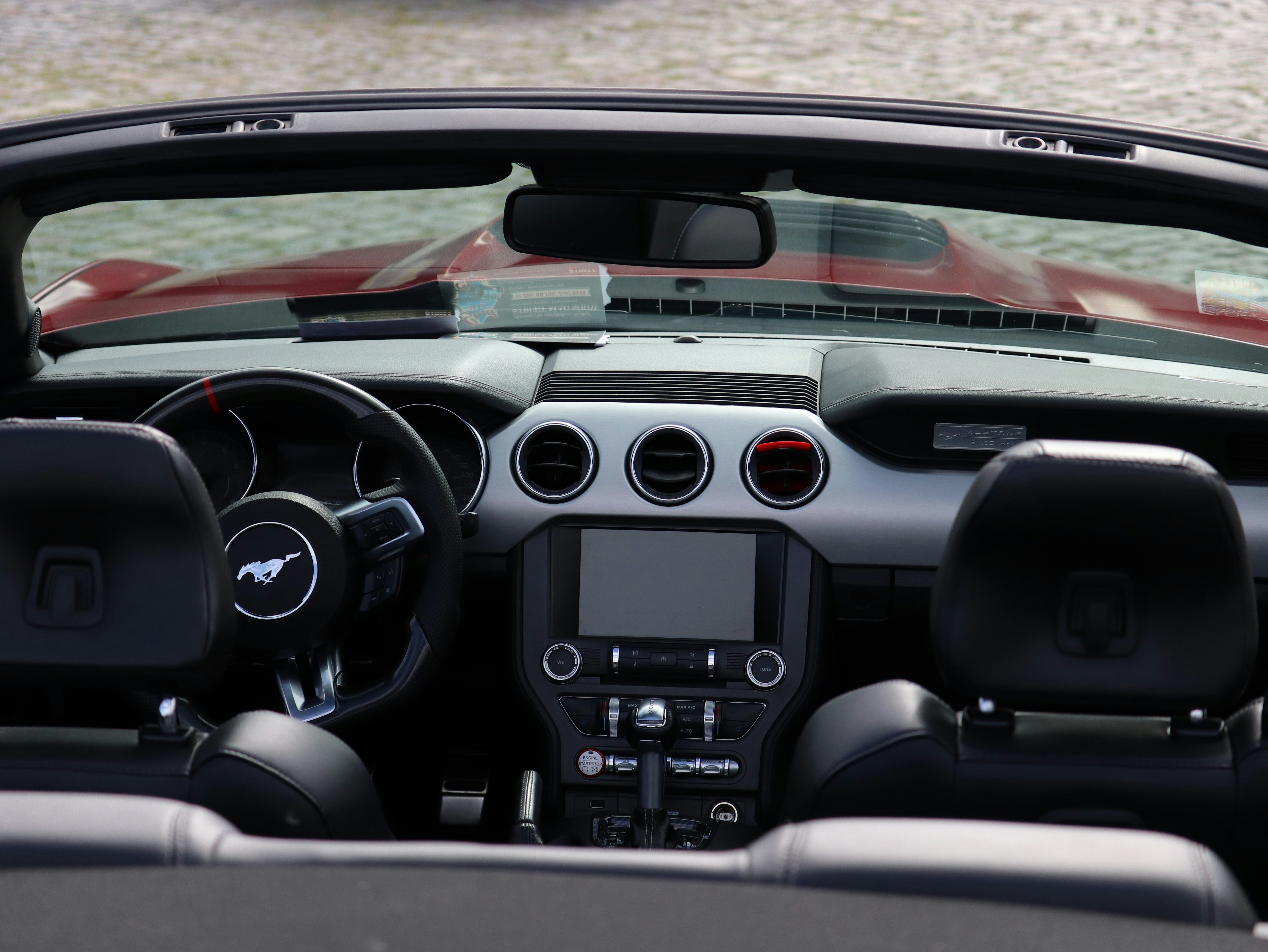  Convertible cockpit: mustang interior framed by red roadster