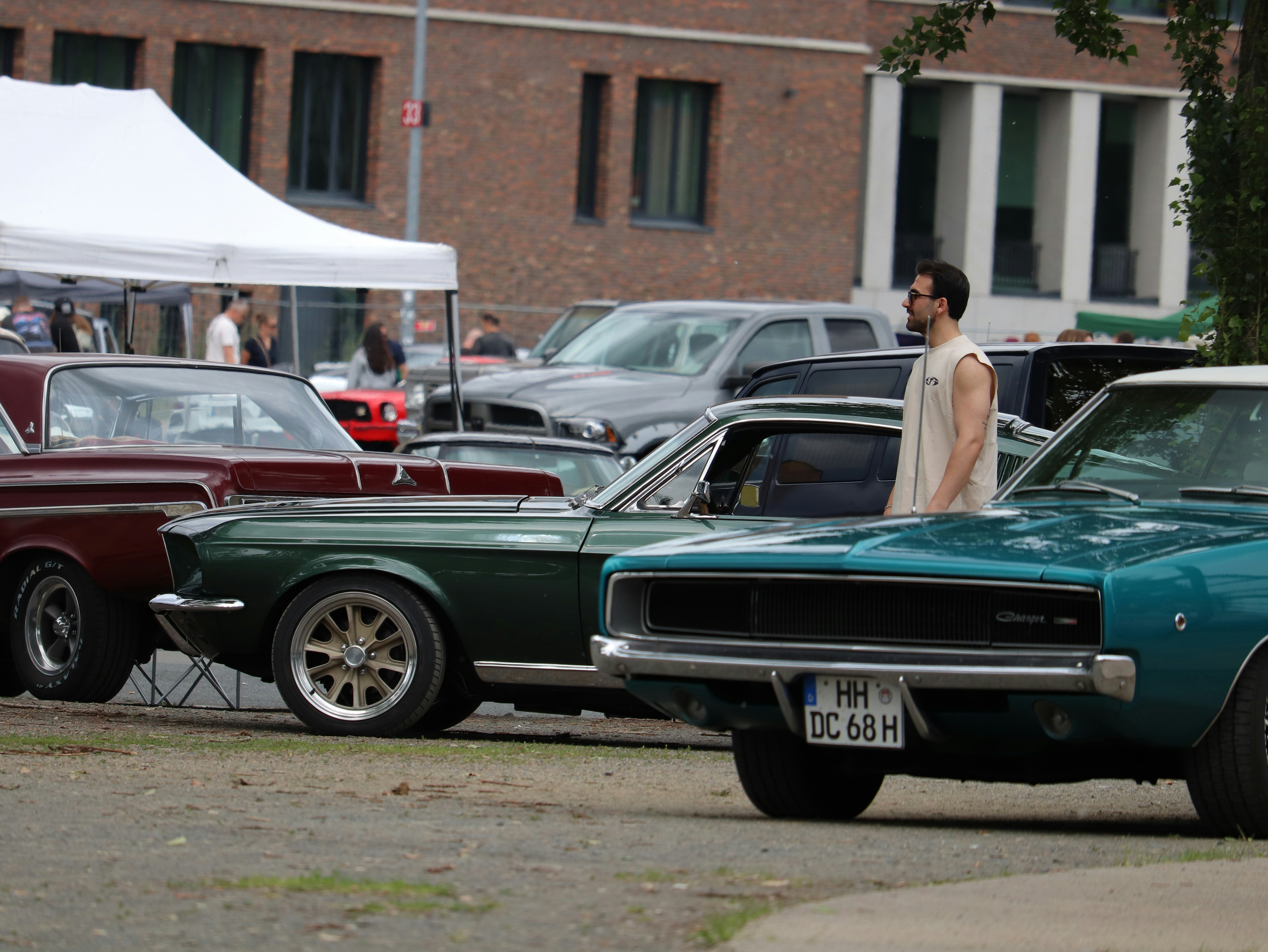 Chrome and Connie: a row of muscle Cars and a lone spectator