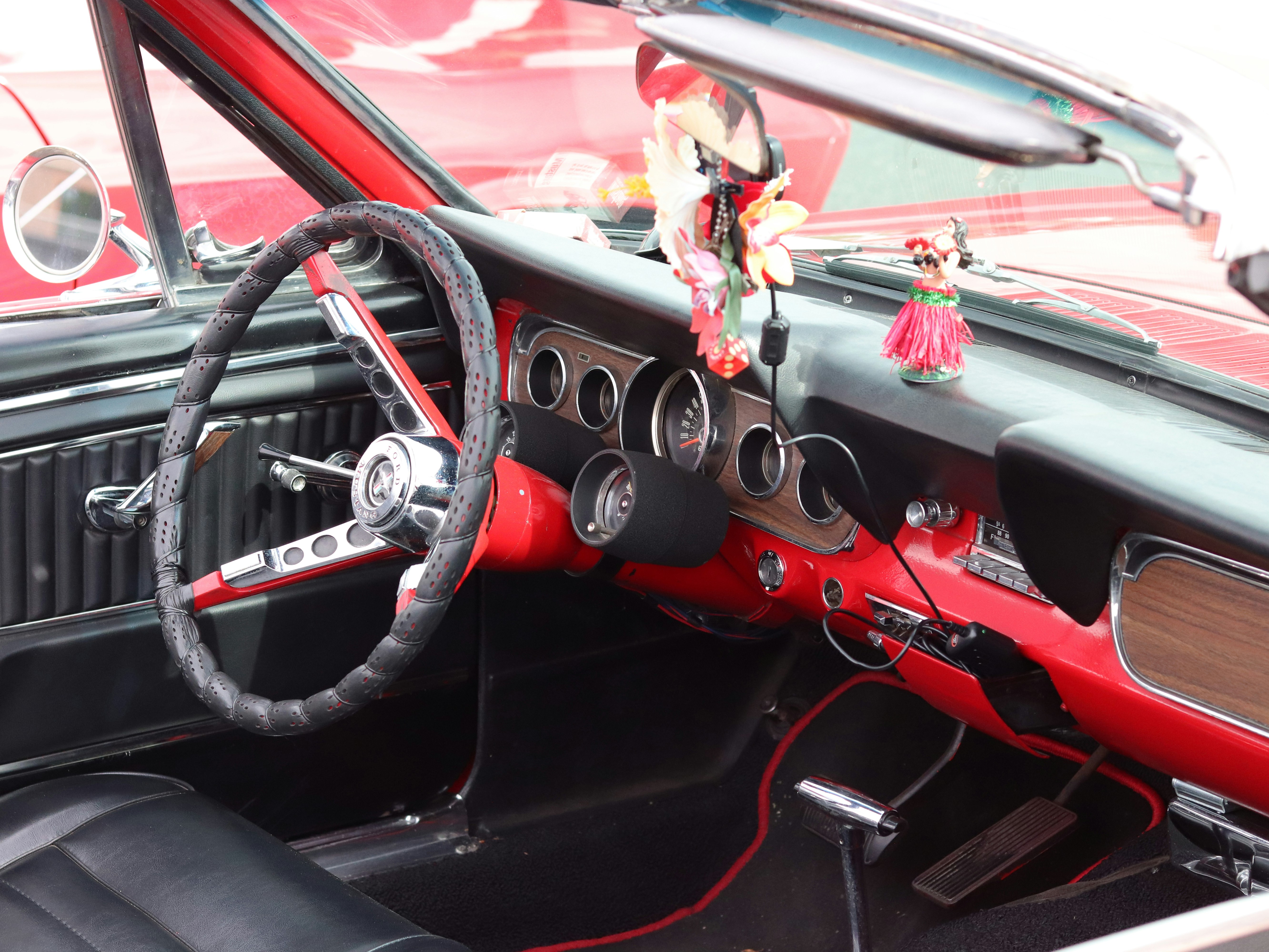 Vintage Red Dash: A Classic Car Interior with Weathered Steering and Hints of Ornament
