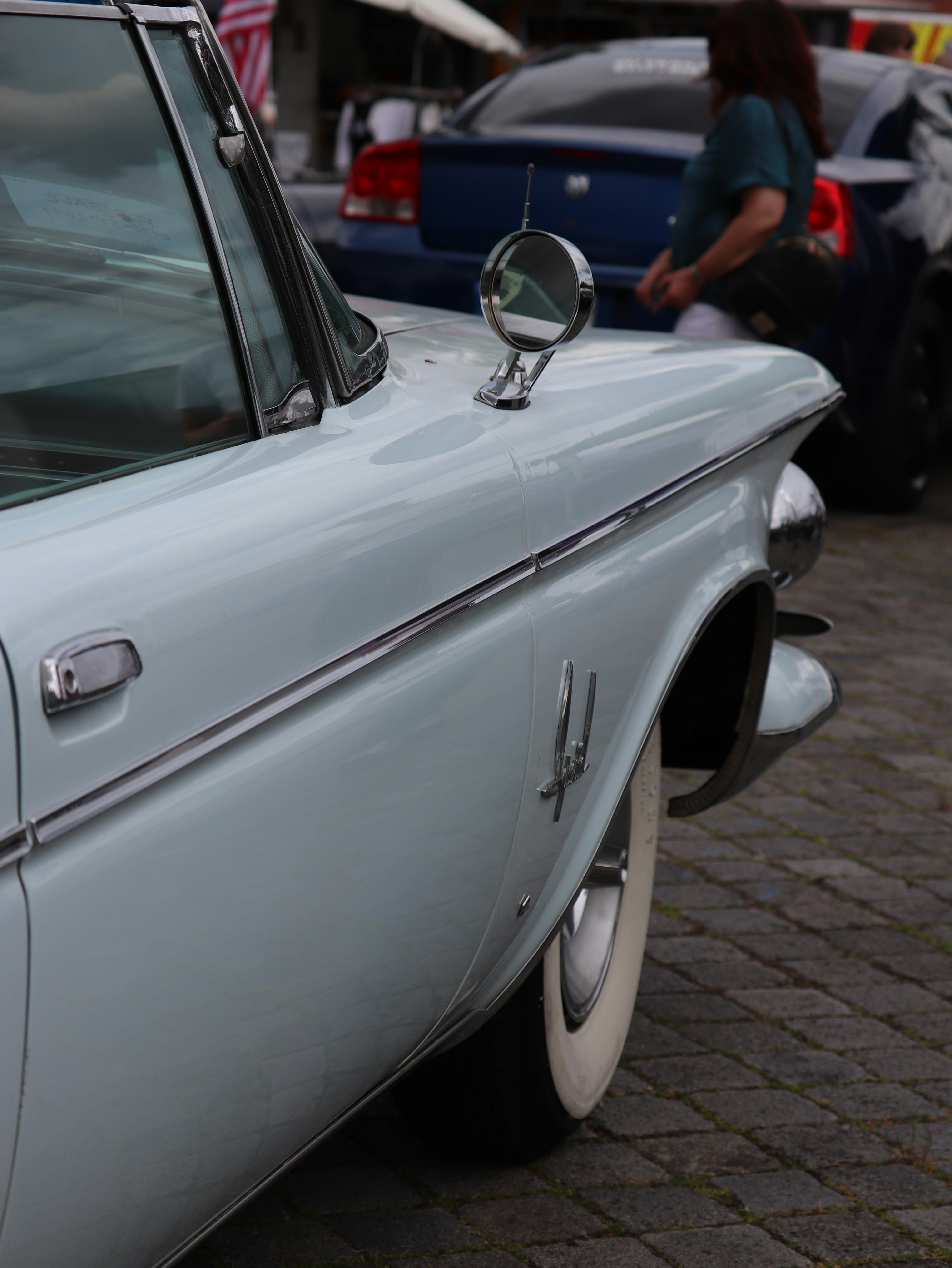 Vintage Car Spotlight: gleaming chrome and pastel blue on cobblestones