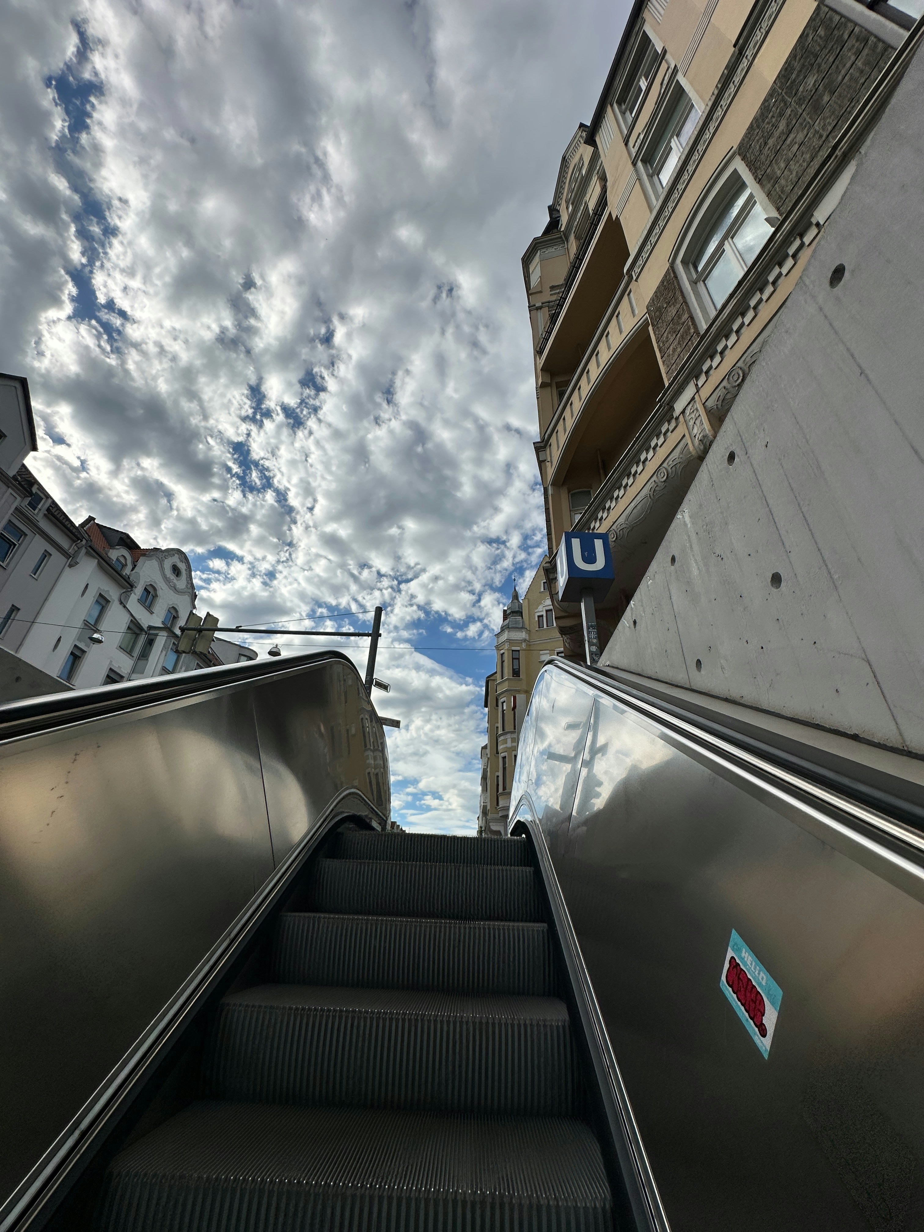 Ascending View: Urban Escalator Framing Under A Skyline