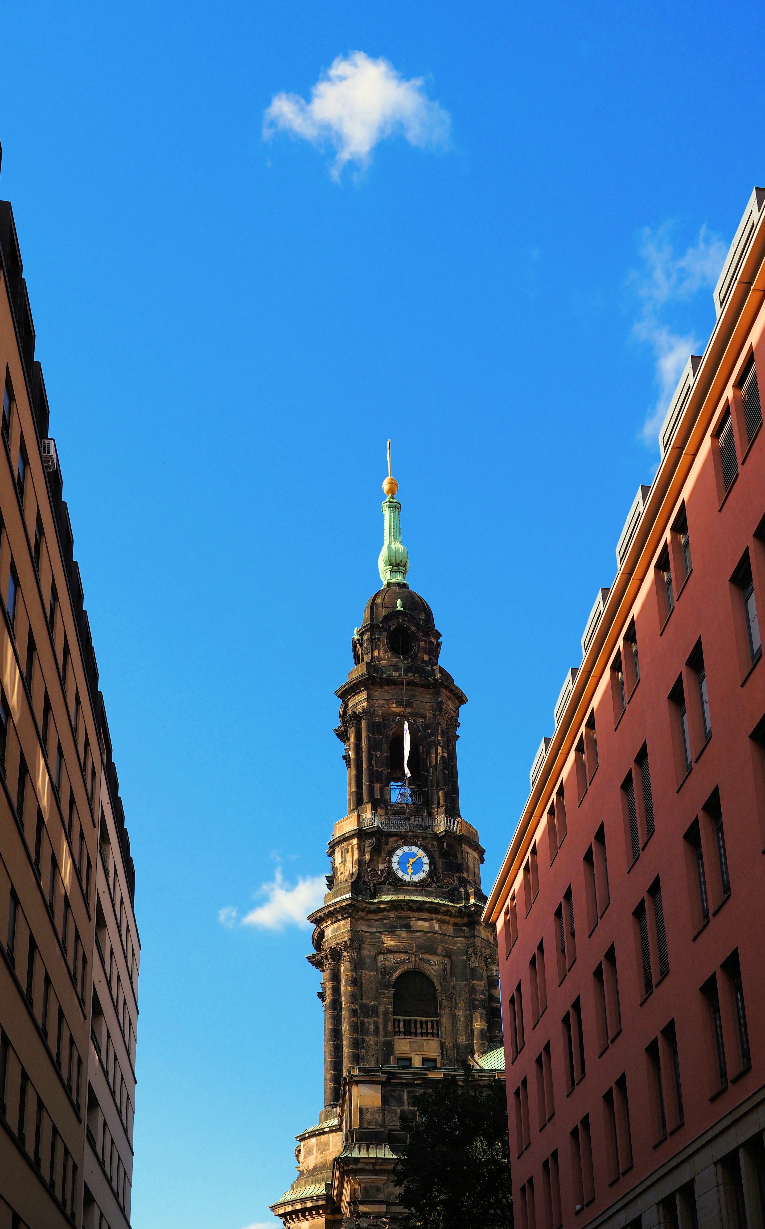 Skyward Clocktower Between Cloistered Facades