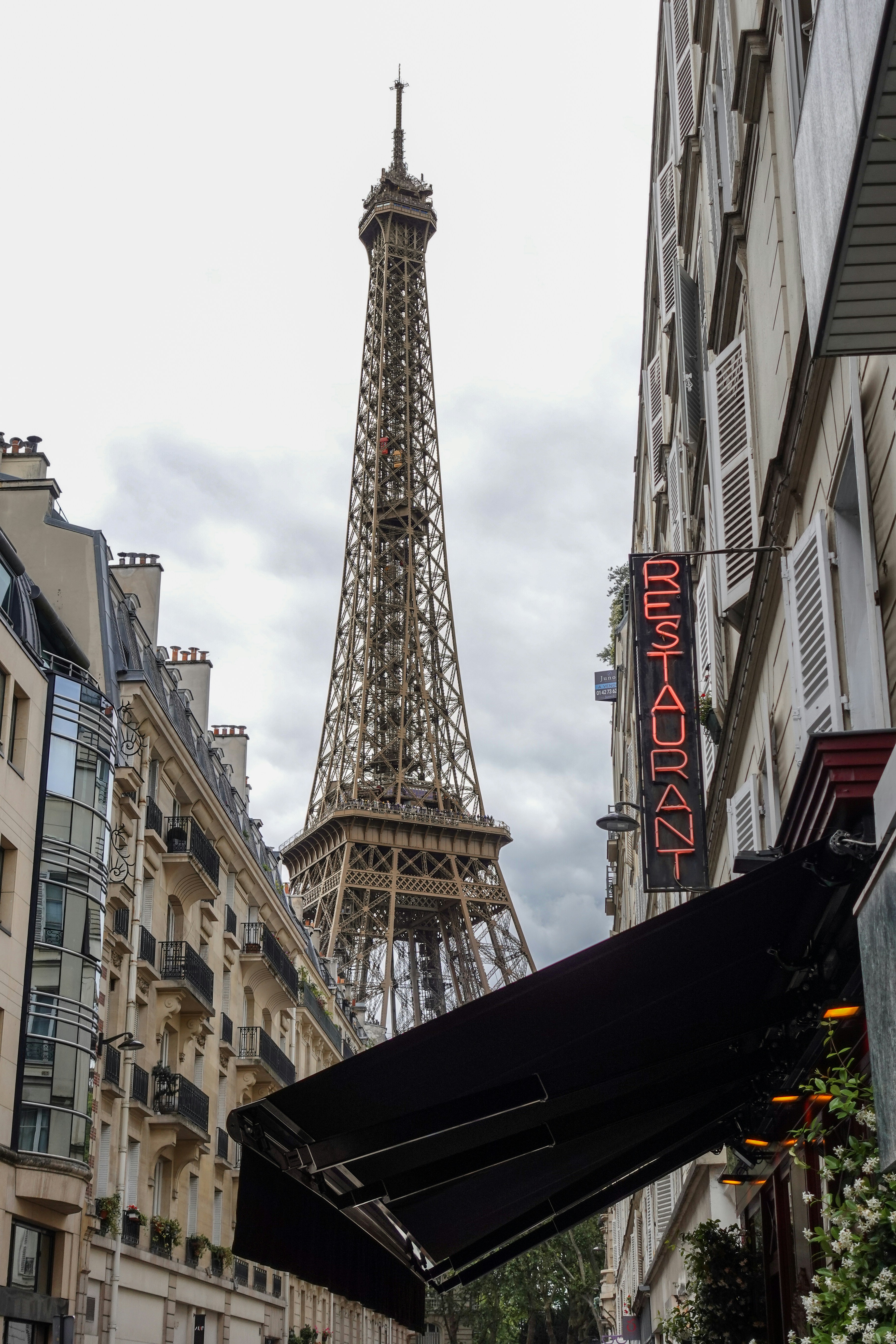 Parisian Vista: The Eiffel Tower Framed Between Classic Façades
