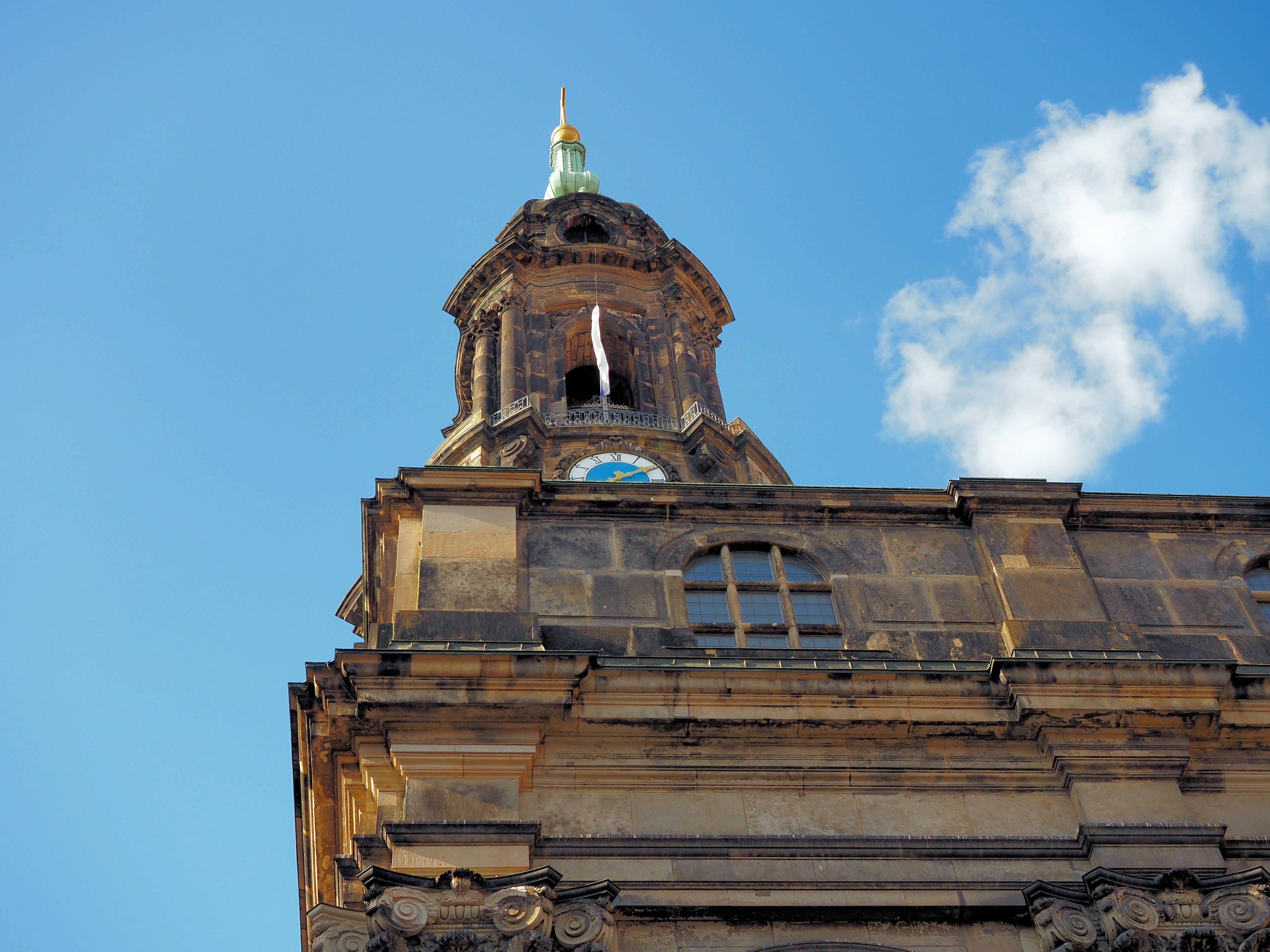 Clocktower Above the Cornice: A Stone Summit Reaches the Sky