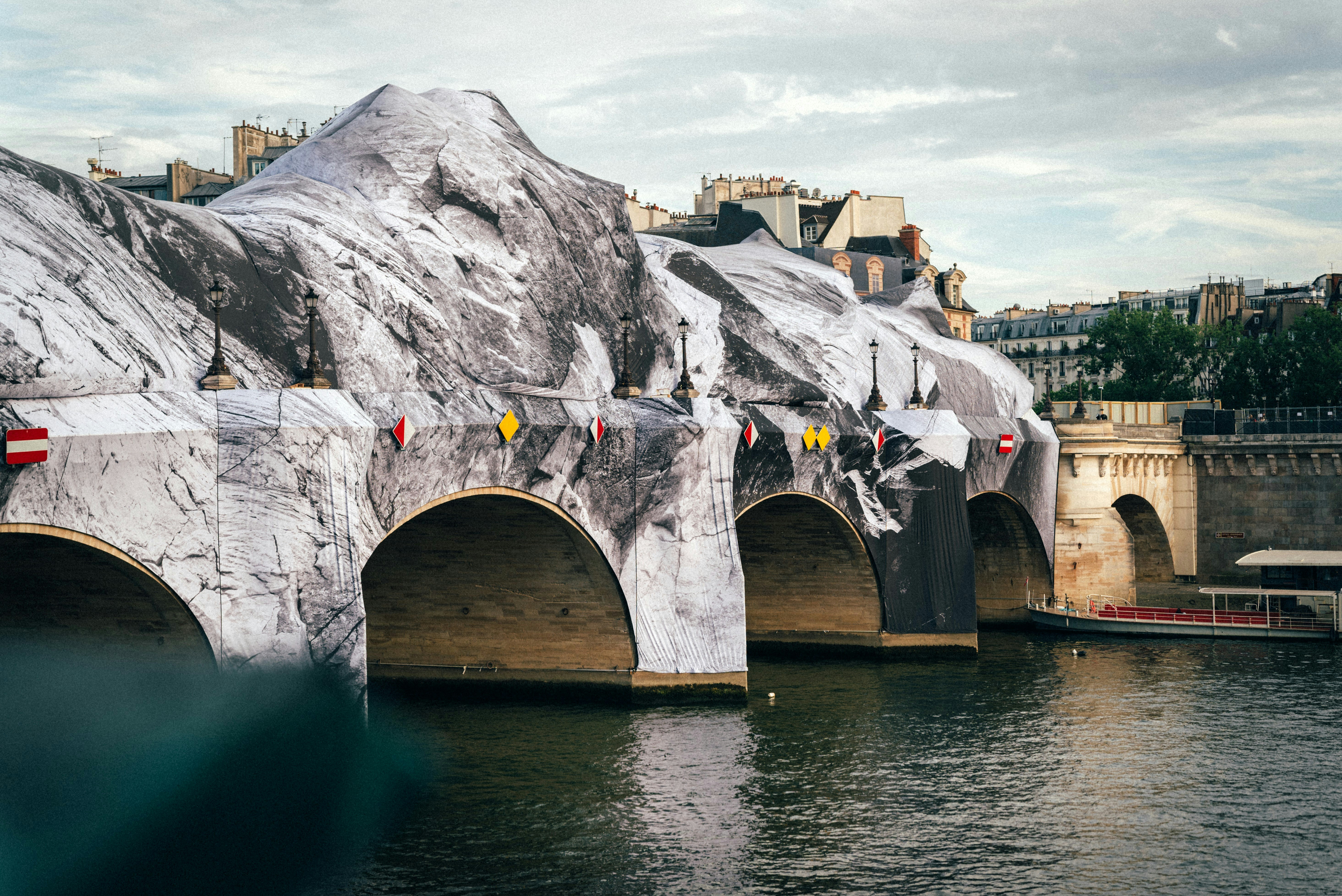 Snow‑capped arches under a sunlit city sky