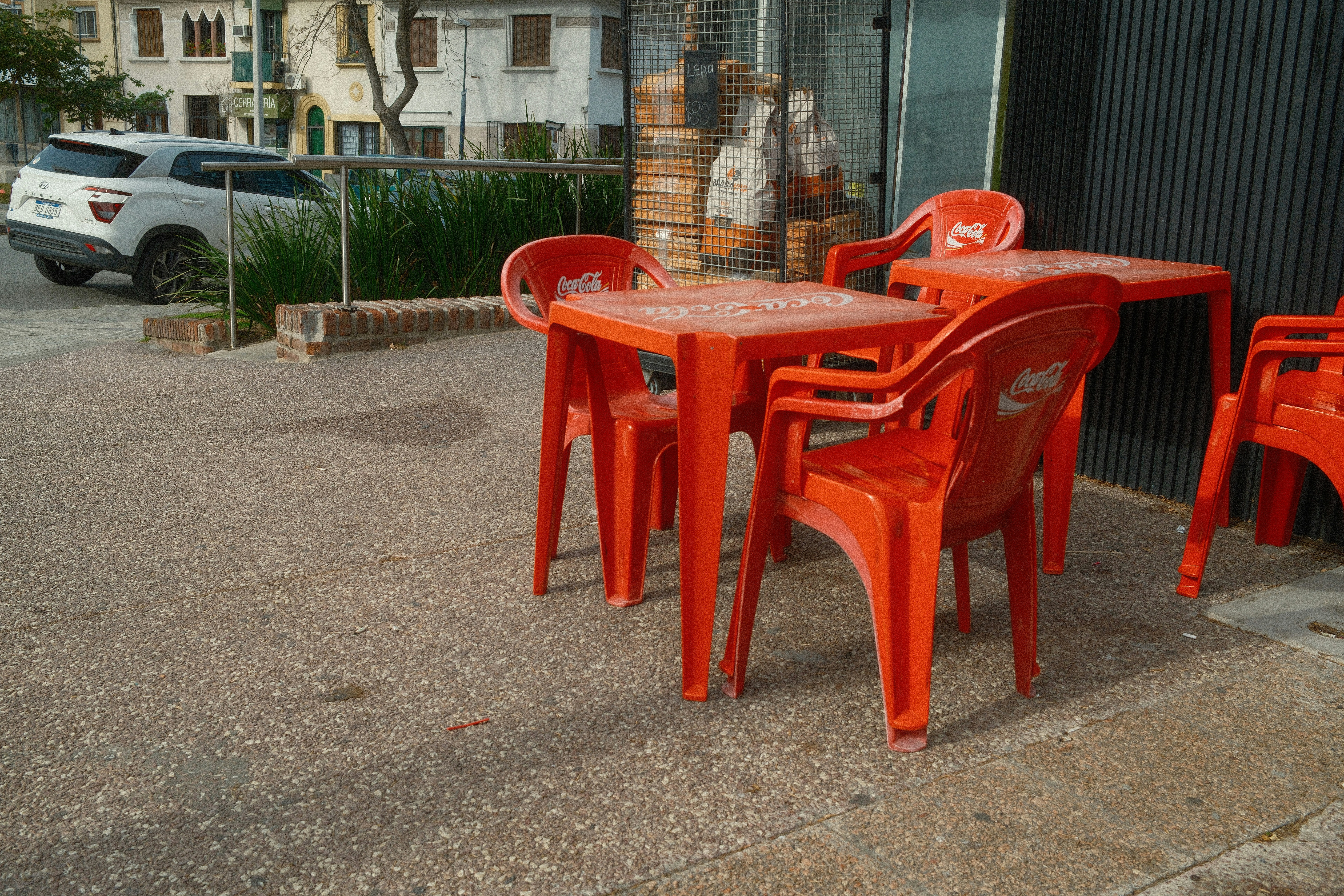 Red Plastic Oasis: Outdoor Café Setup in Warm daylight