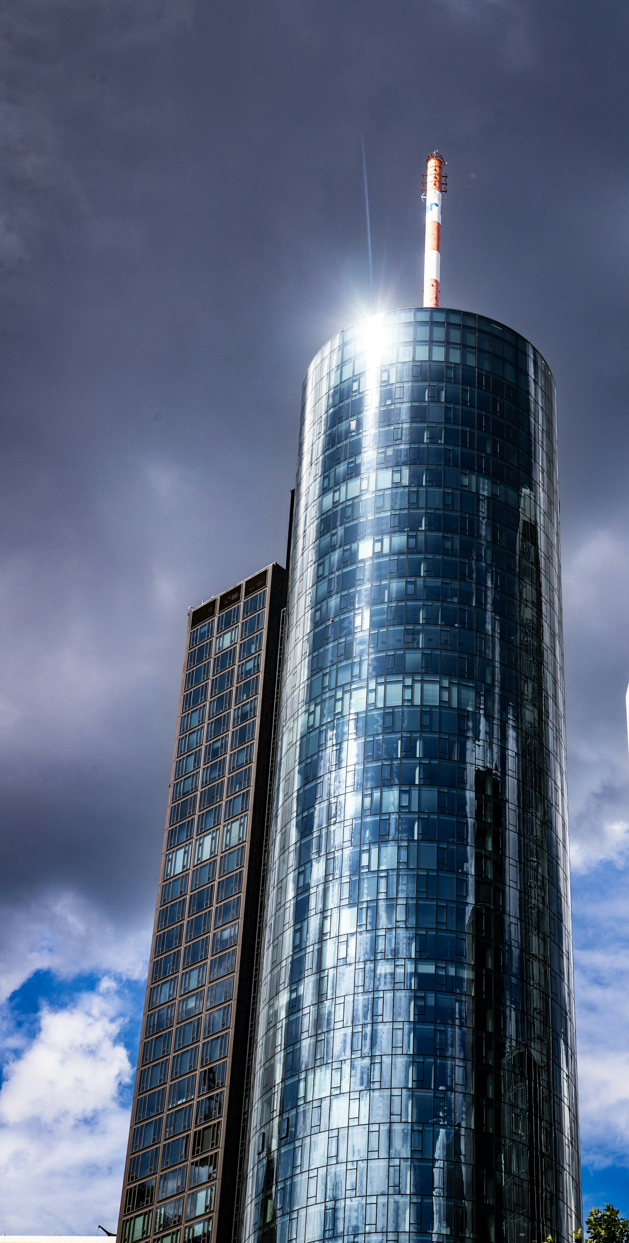 Reflective Glass Tower Reaching Toward a Stormy Sky