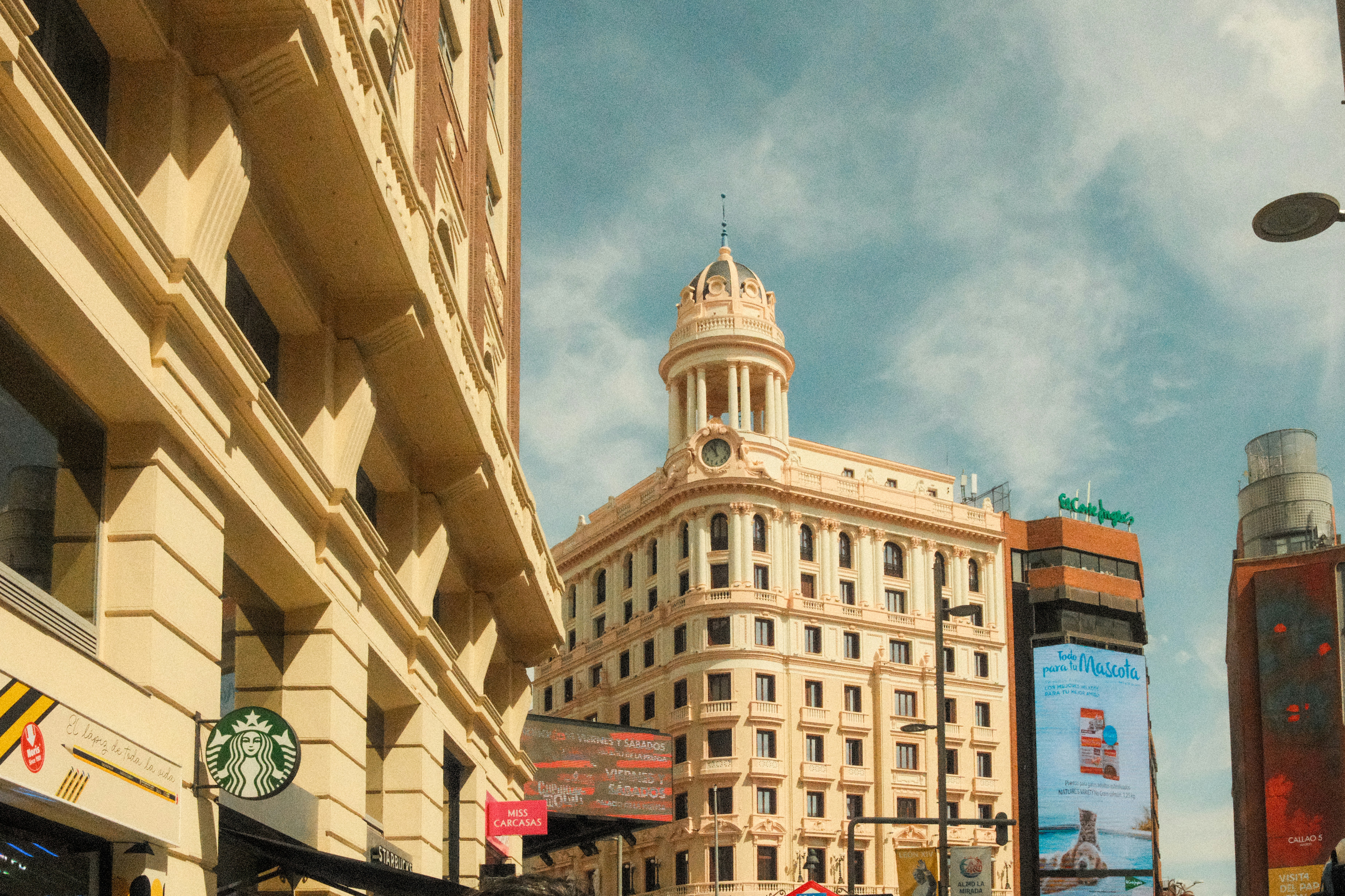 Urban Beacon: The Curved Clocktower Crown Above a Sunlit Boulevard