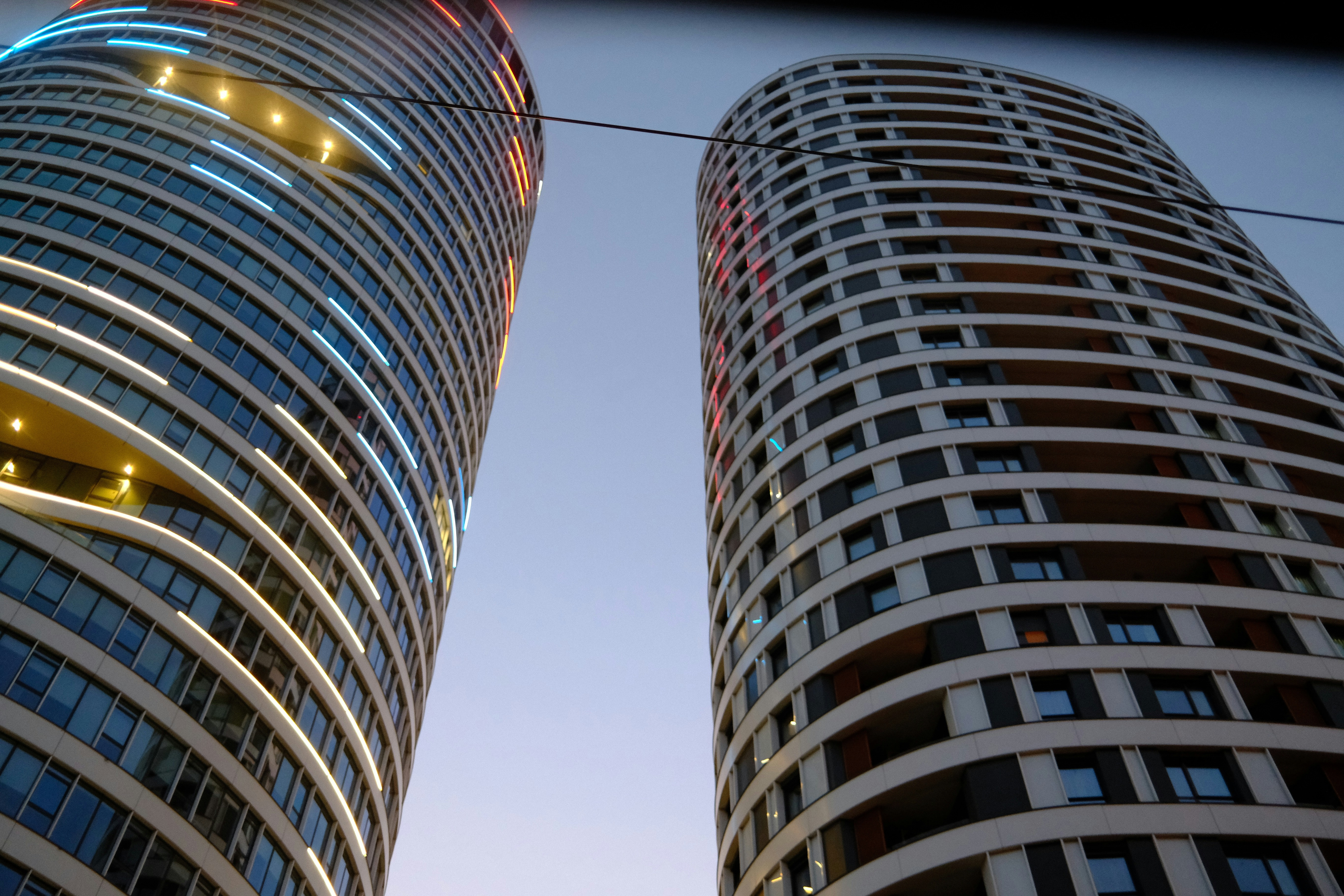Twin Towers Looming: Night‑Lit Curves Meeting a Skyward Gap