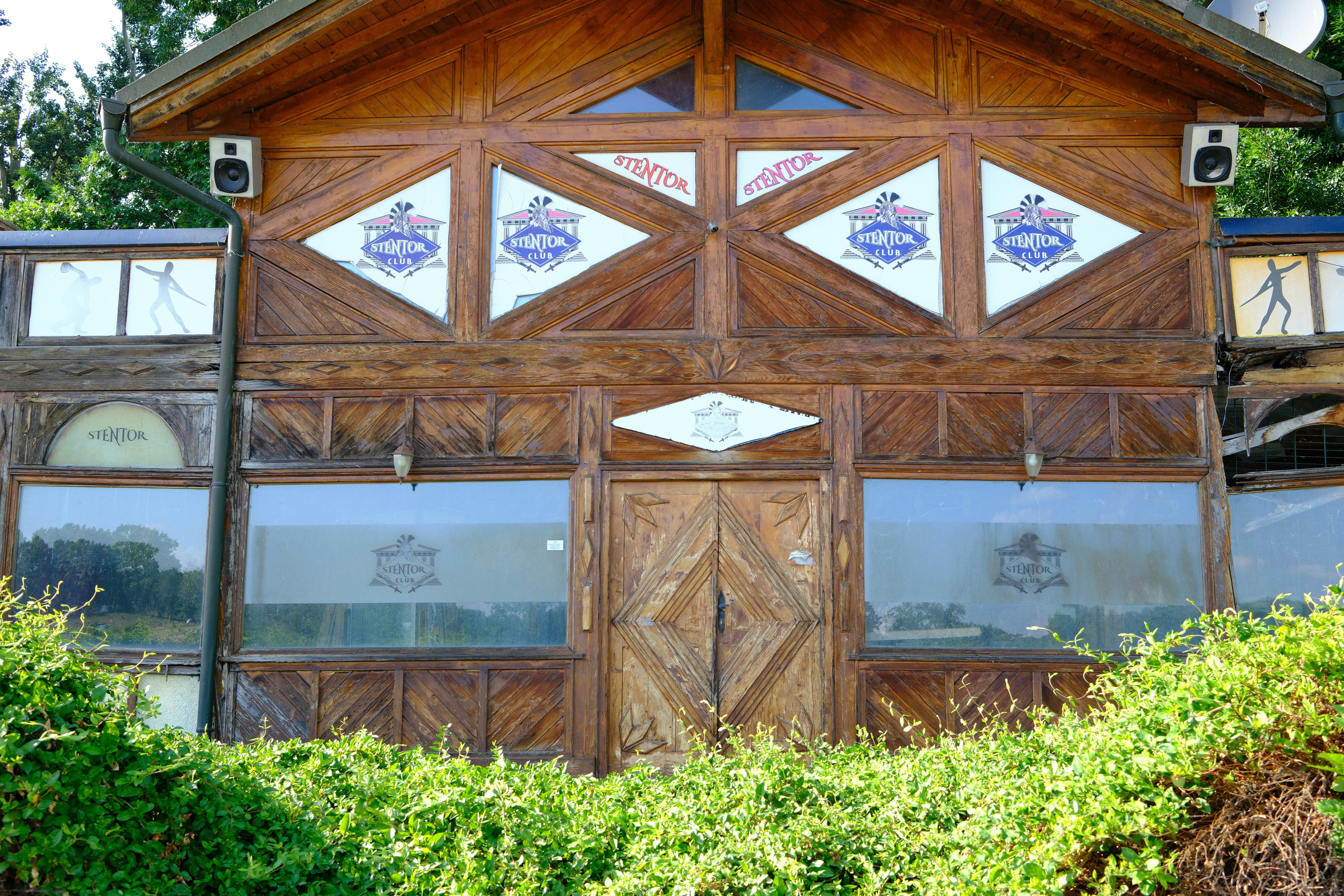 Symmetrical Timber Facade with Central Doorway and Framing Windows