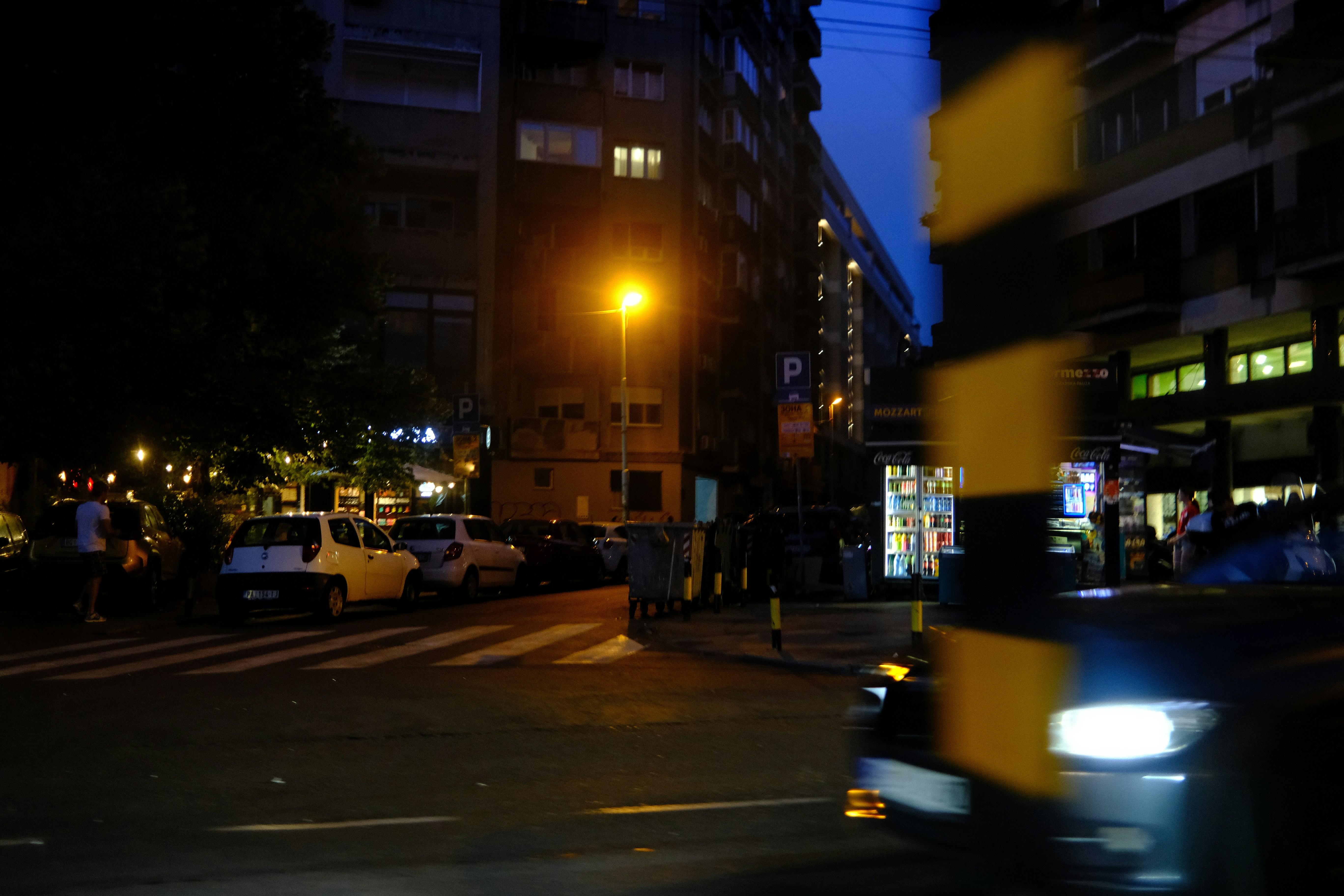 Night Street Pulse: A Blur of Traffic Under Street Lamps