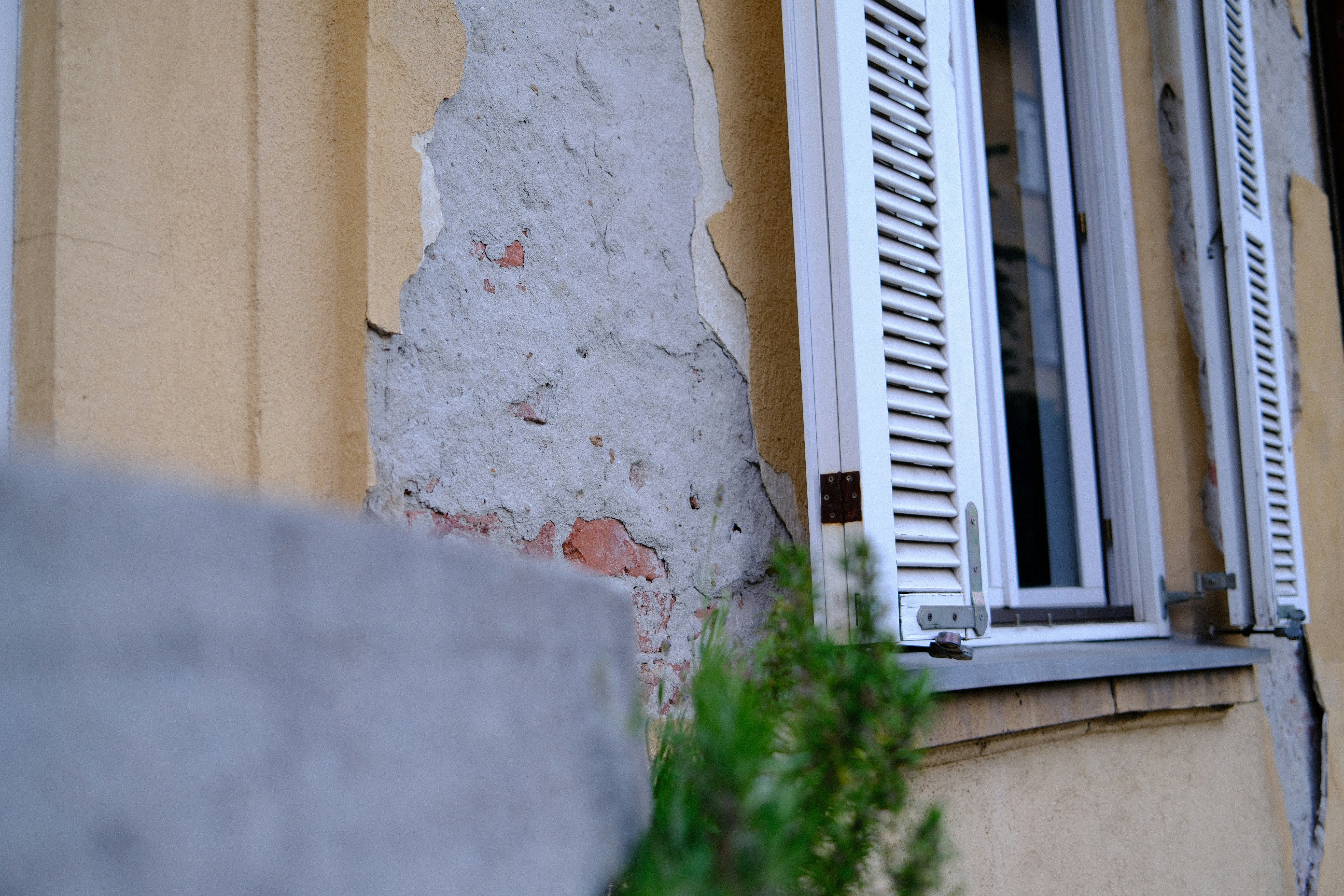Sunlit Window Frame with Weathered Wall