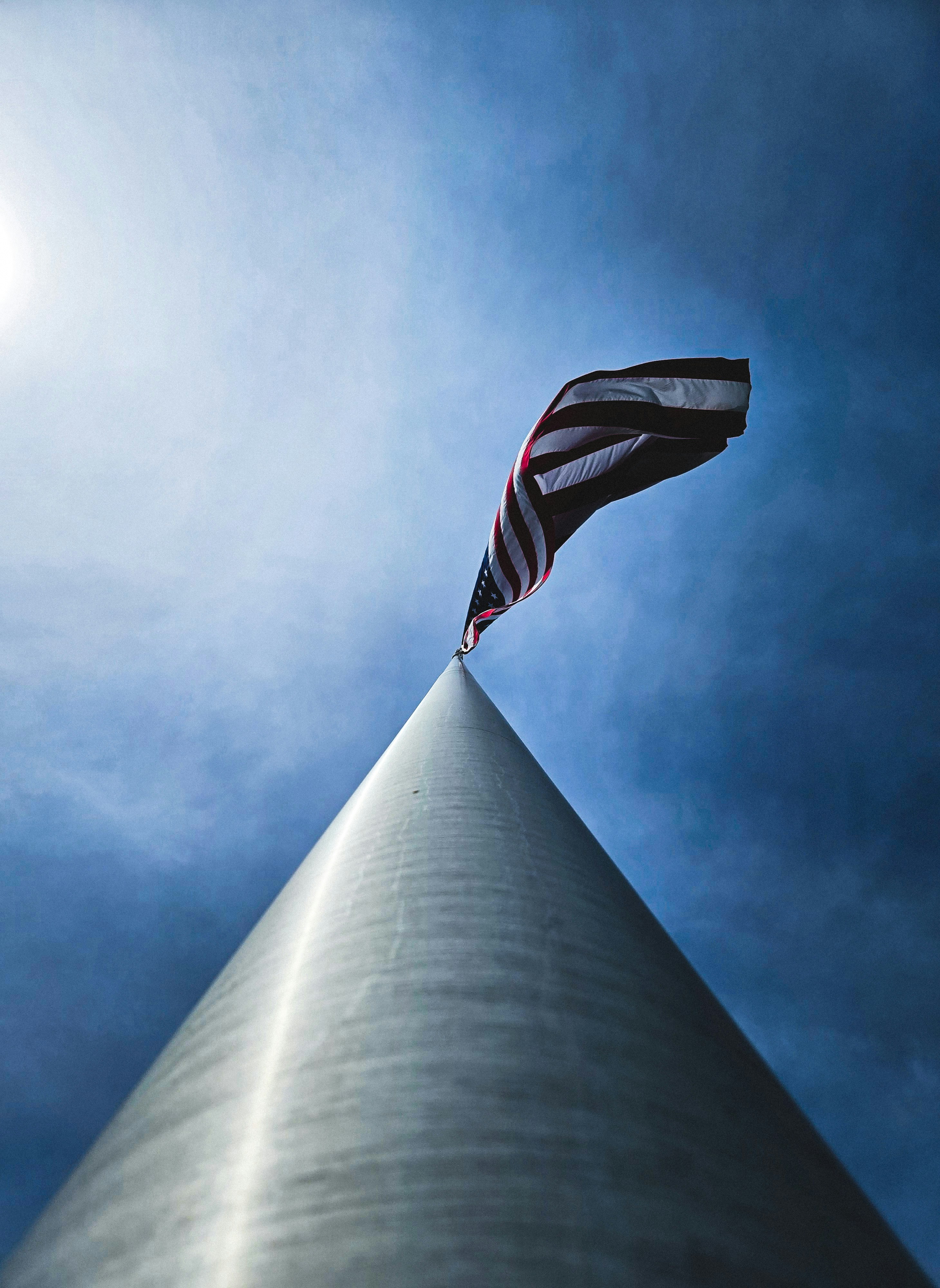 Flag at the Peak: A Low-Aangle Portrait of Freedom