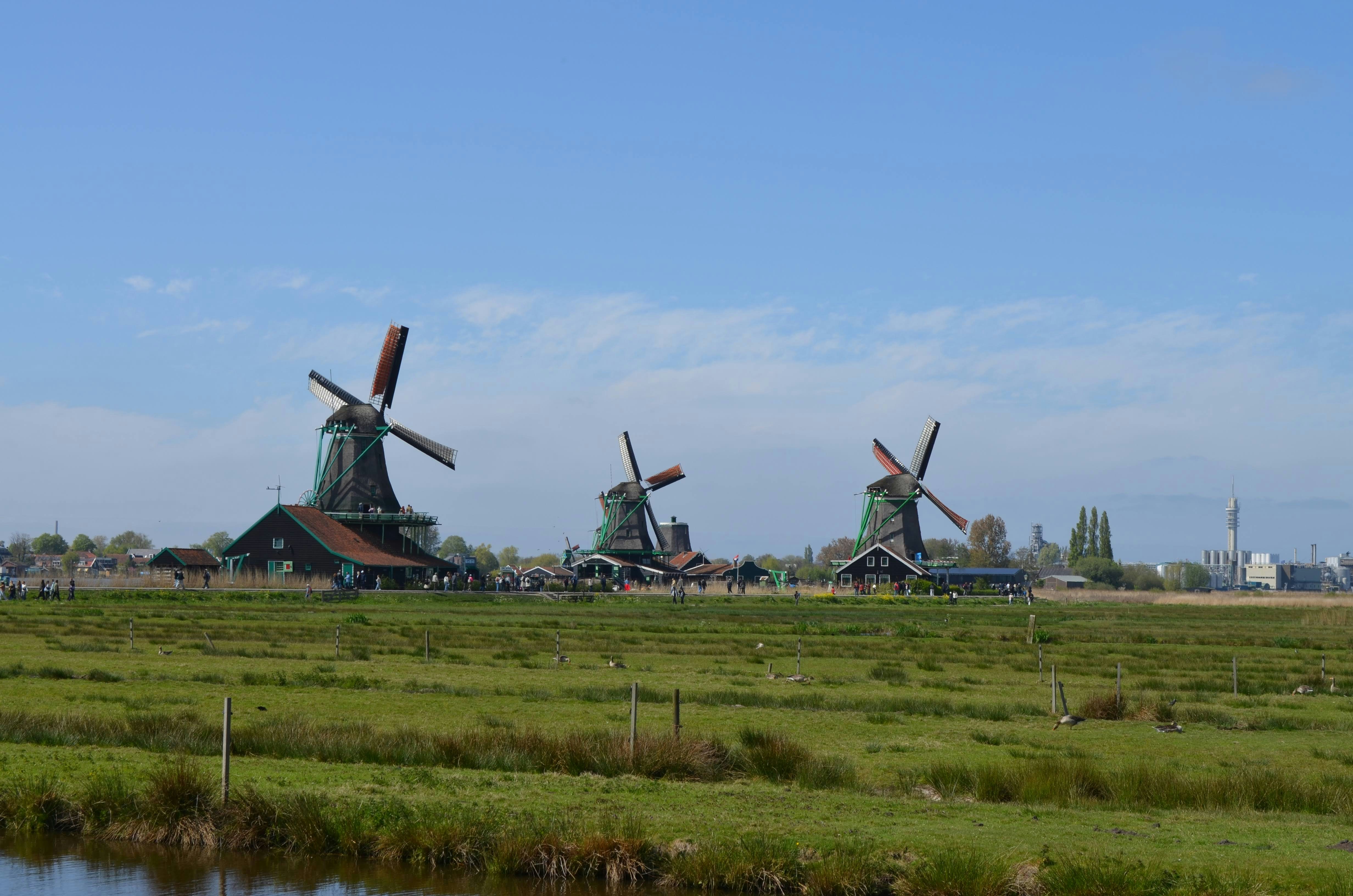 Three Dutch Windmills on a Quiet Embankment