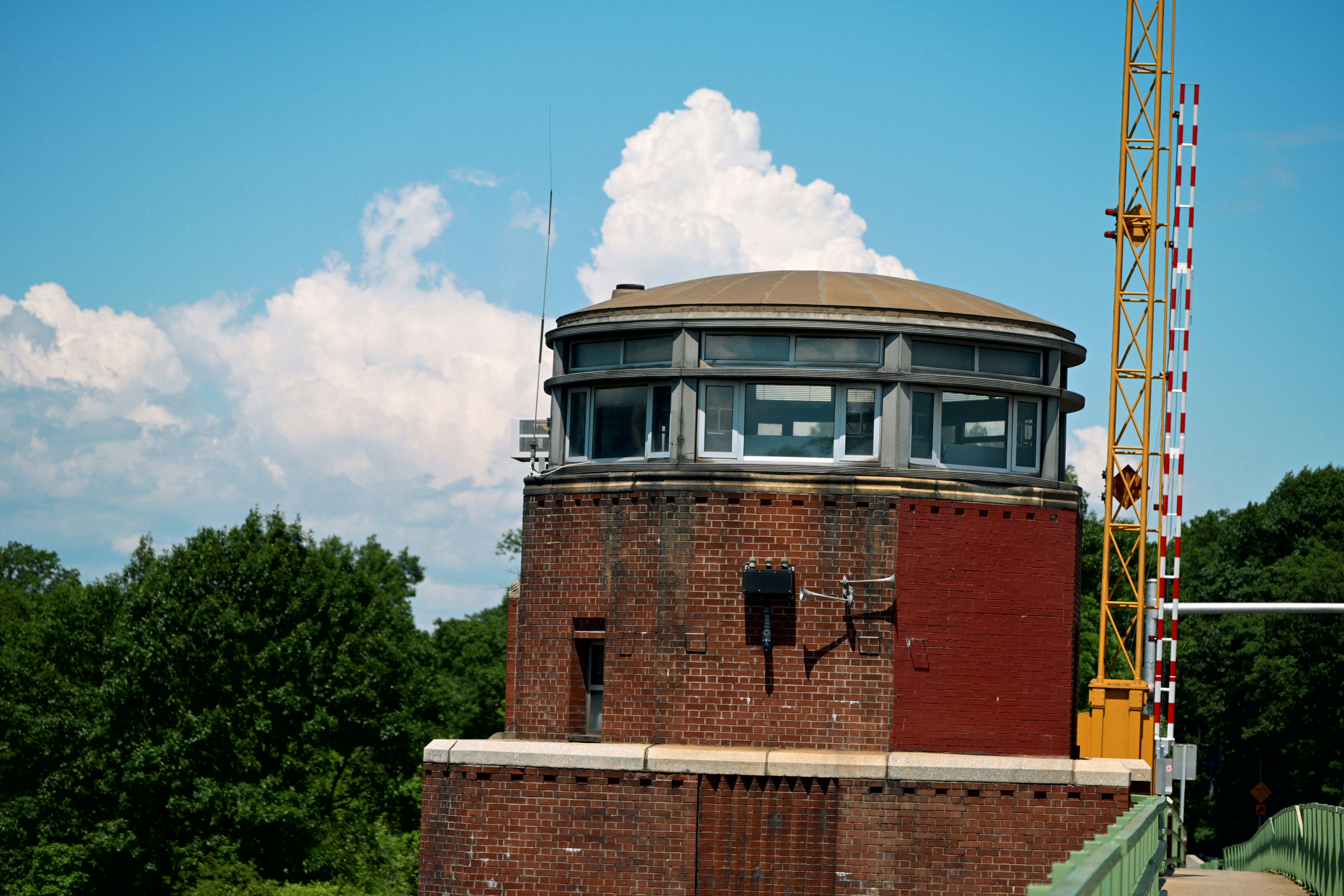 Brick Watchtower under a Clear Sky with Construction Crane