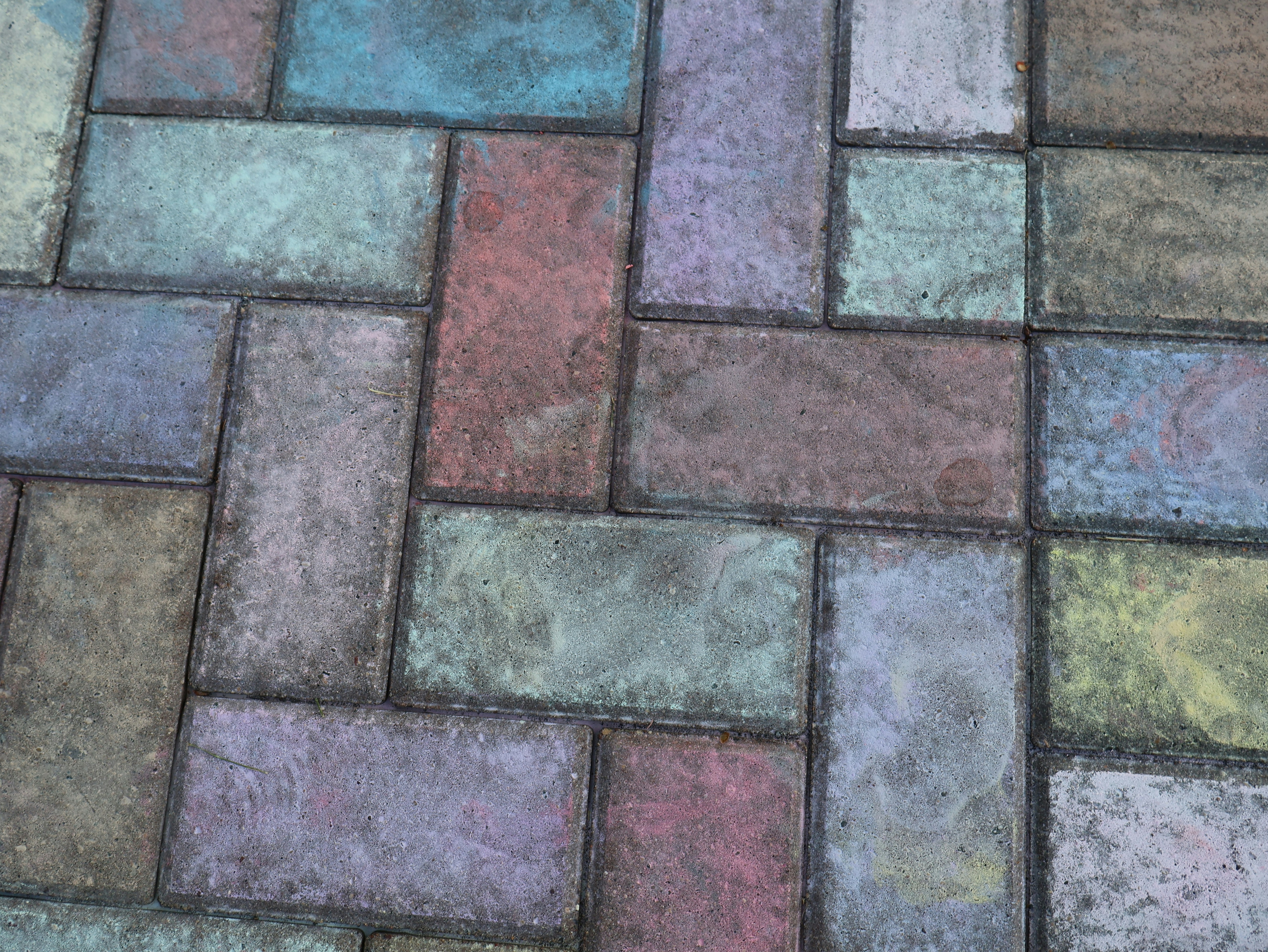 Chalk art done by young children to a Burnsville Heart of the City concrete brick walkway