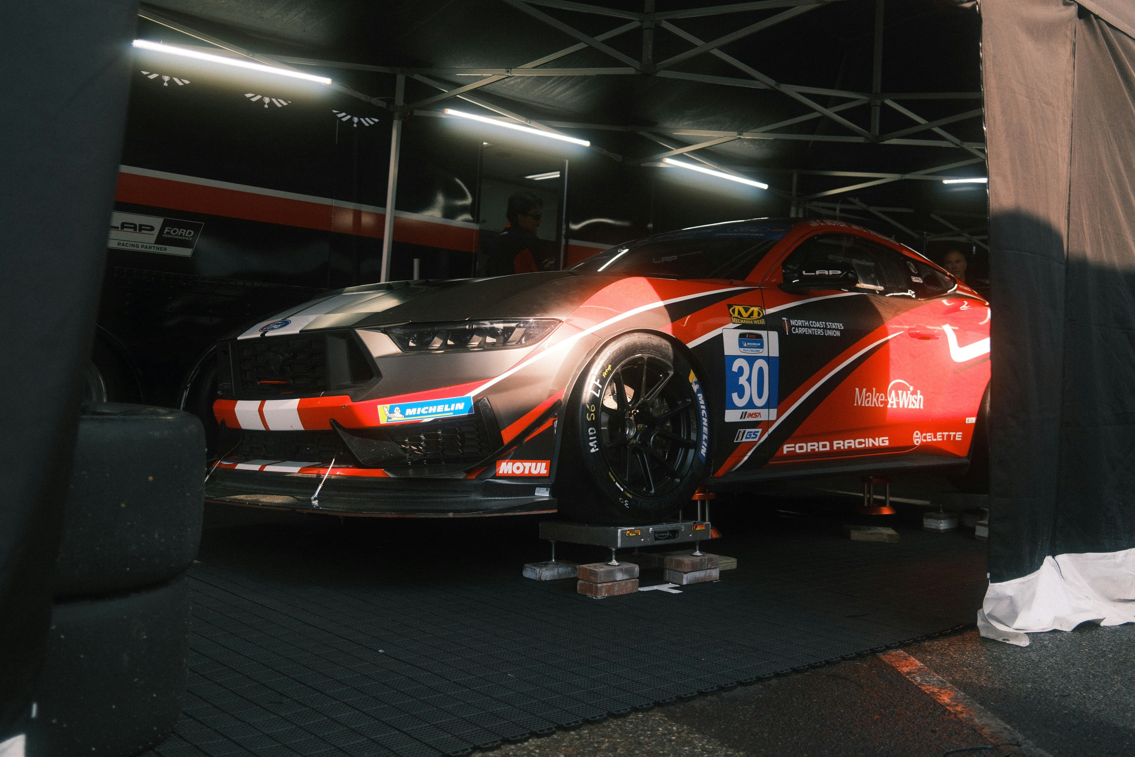 Red racer in the pit under bright canopy lights