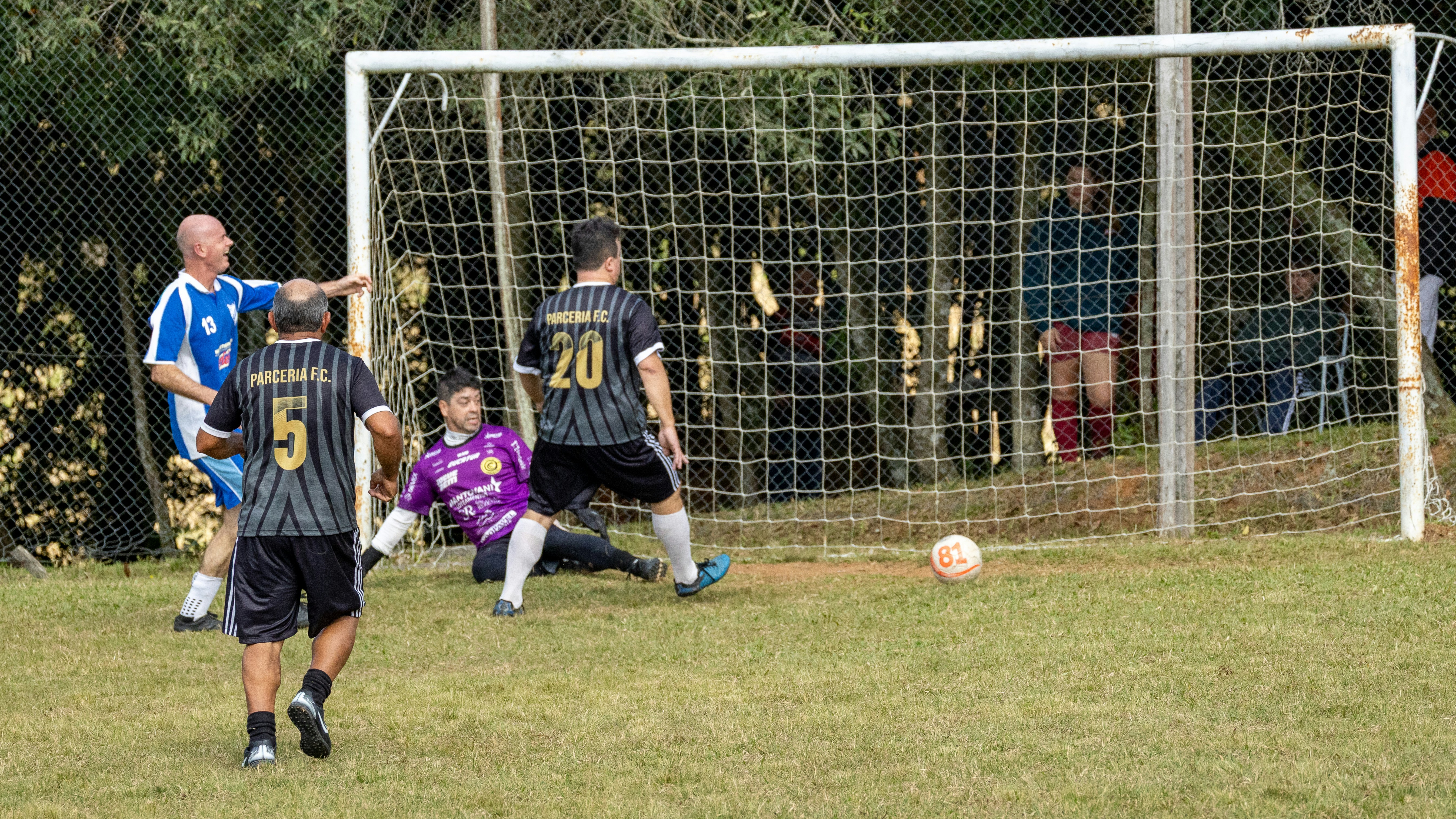 Soccer players near the goal during a game.