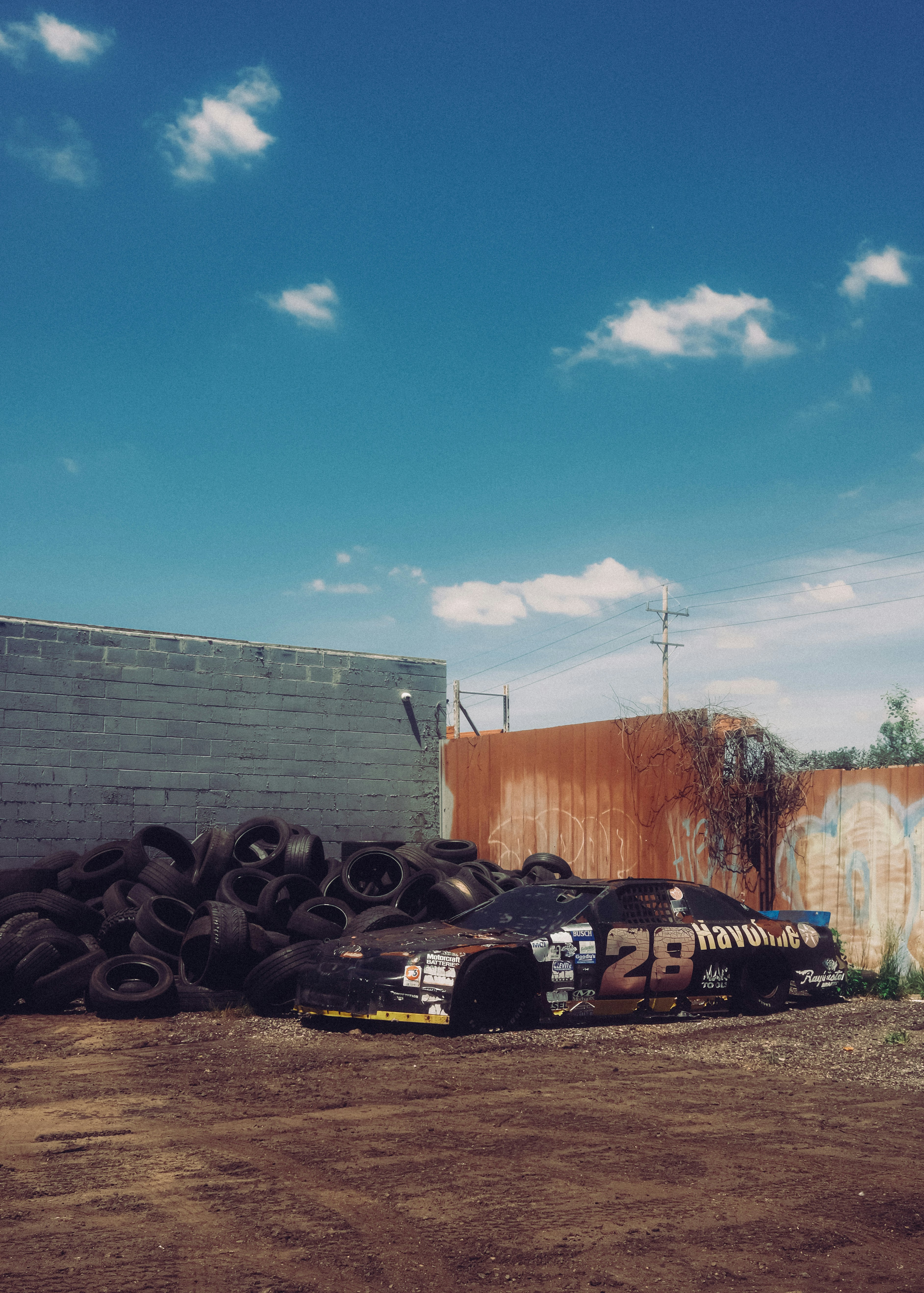 Dusty Yard Legend: Car Shell and Pile of Tires