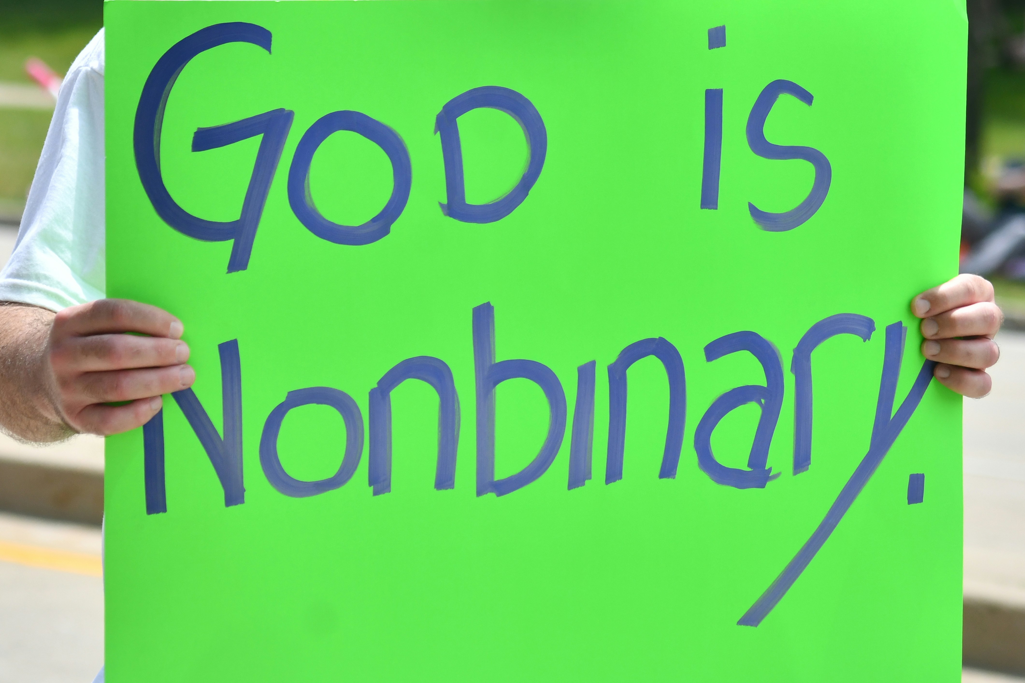 Green Protest Sign: God is Nonbinary in a Bright Public Display