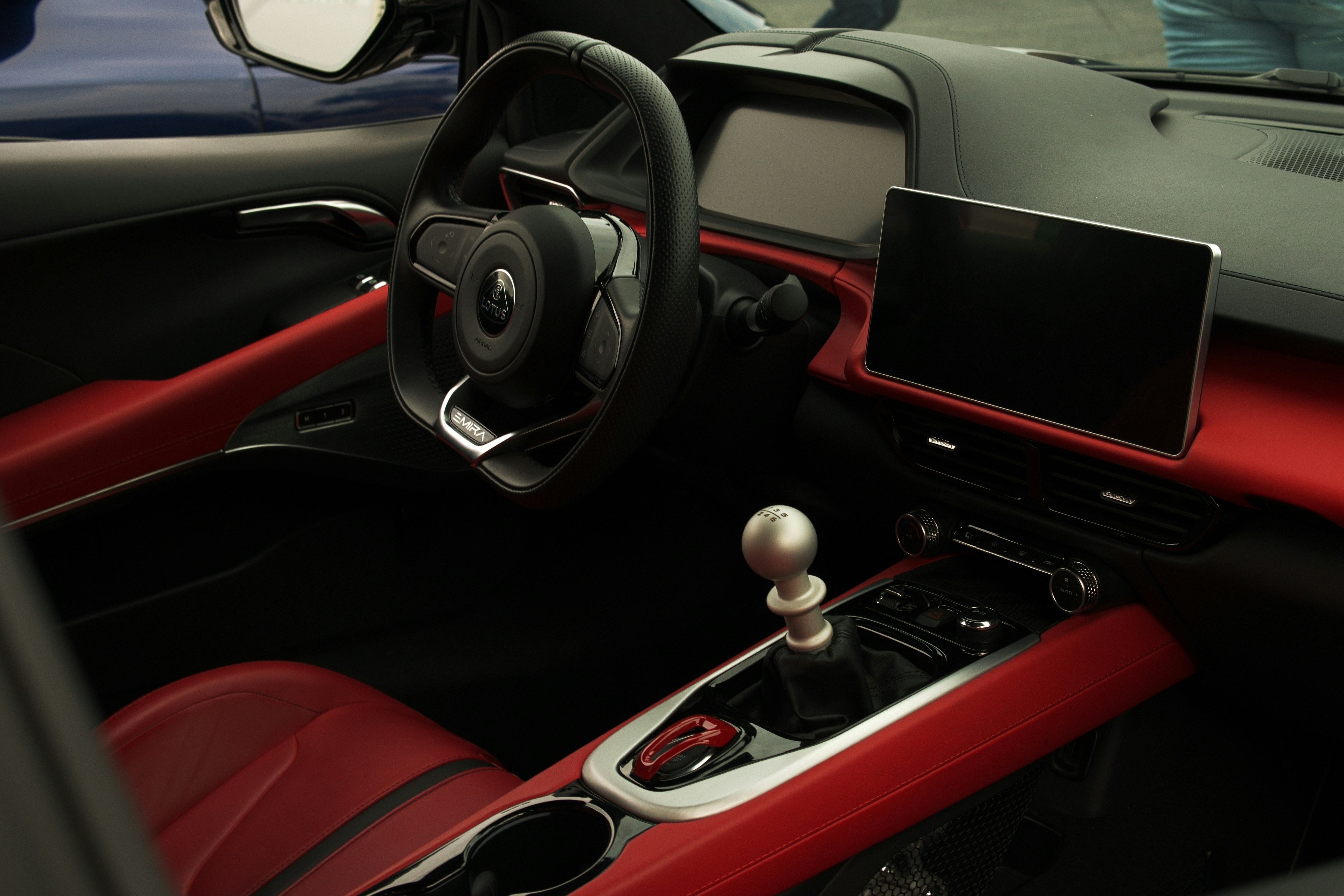 Red-and-Black Cockpit: A Luxe Car Interior with Glossy Display